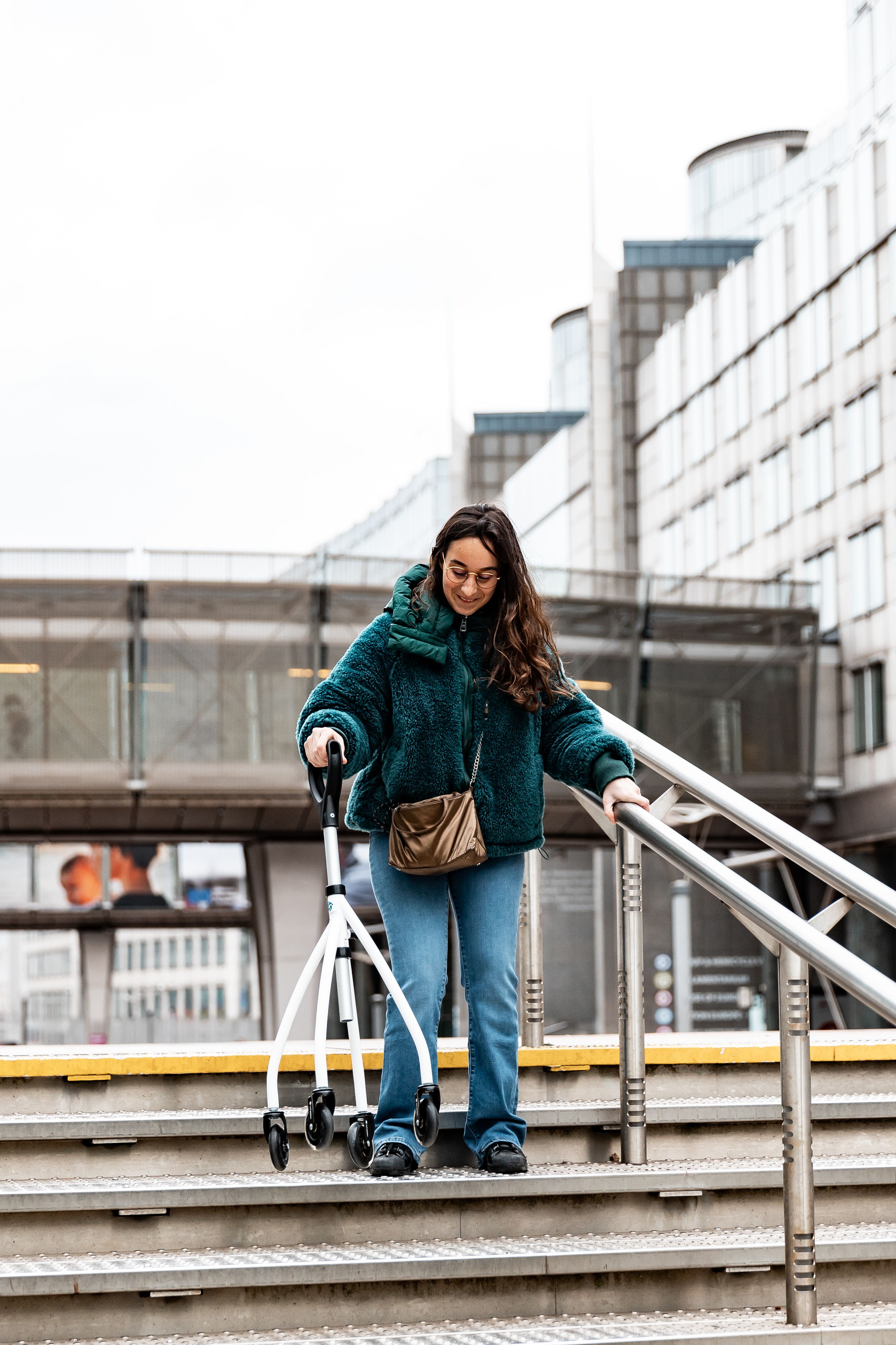 Young Woman with Rollator on Urban Staircase · Free Stock Photo
