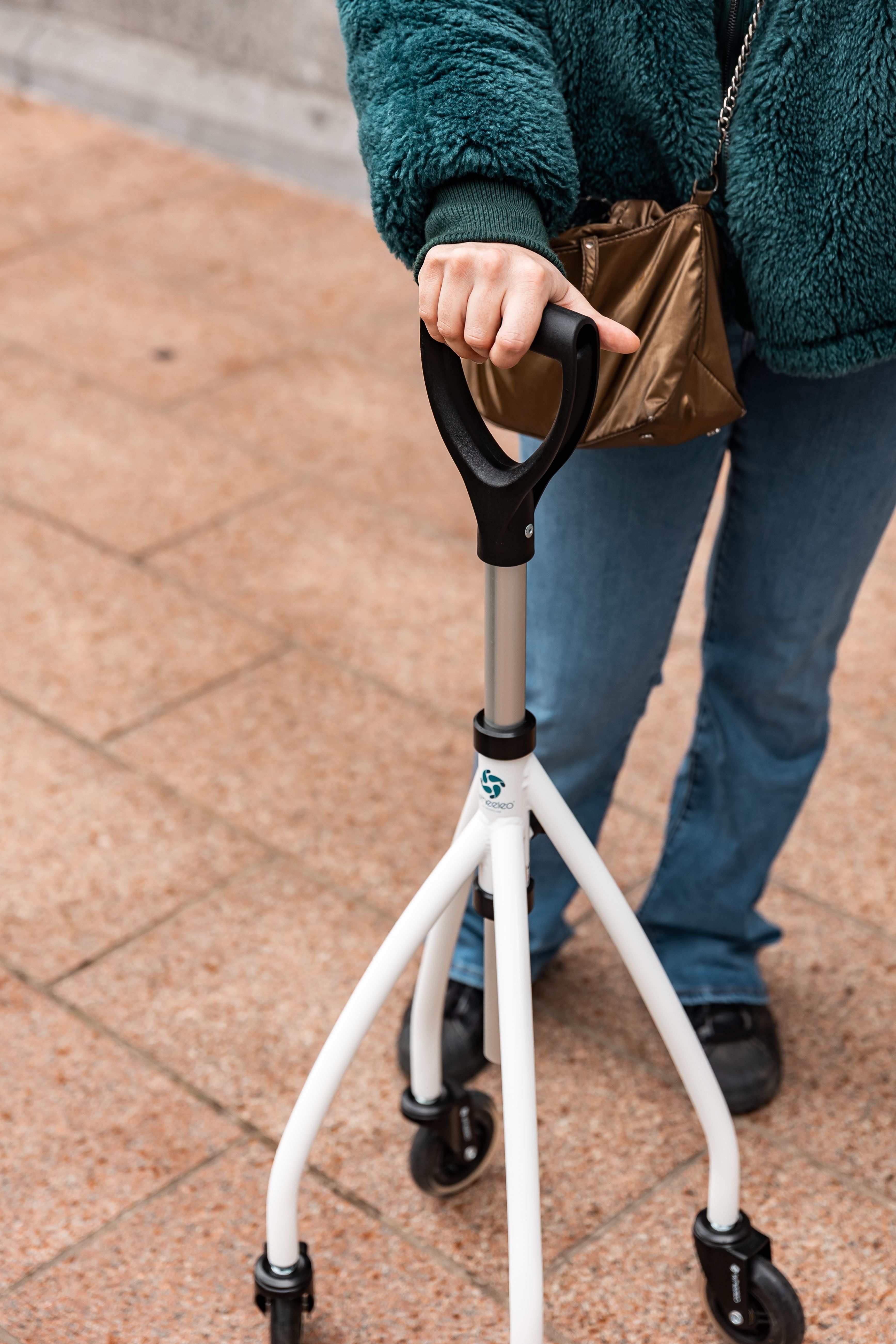 Person Using Mobility Aid on Urban Pathway · Free Stock Photo