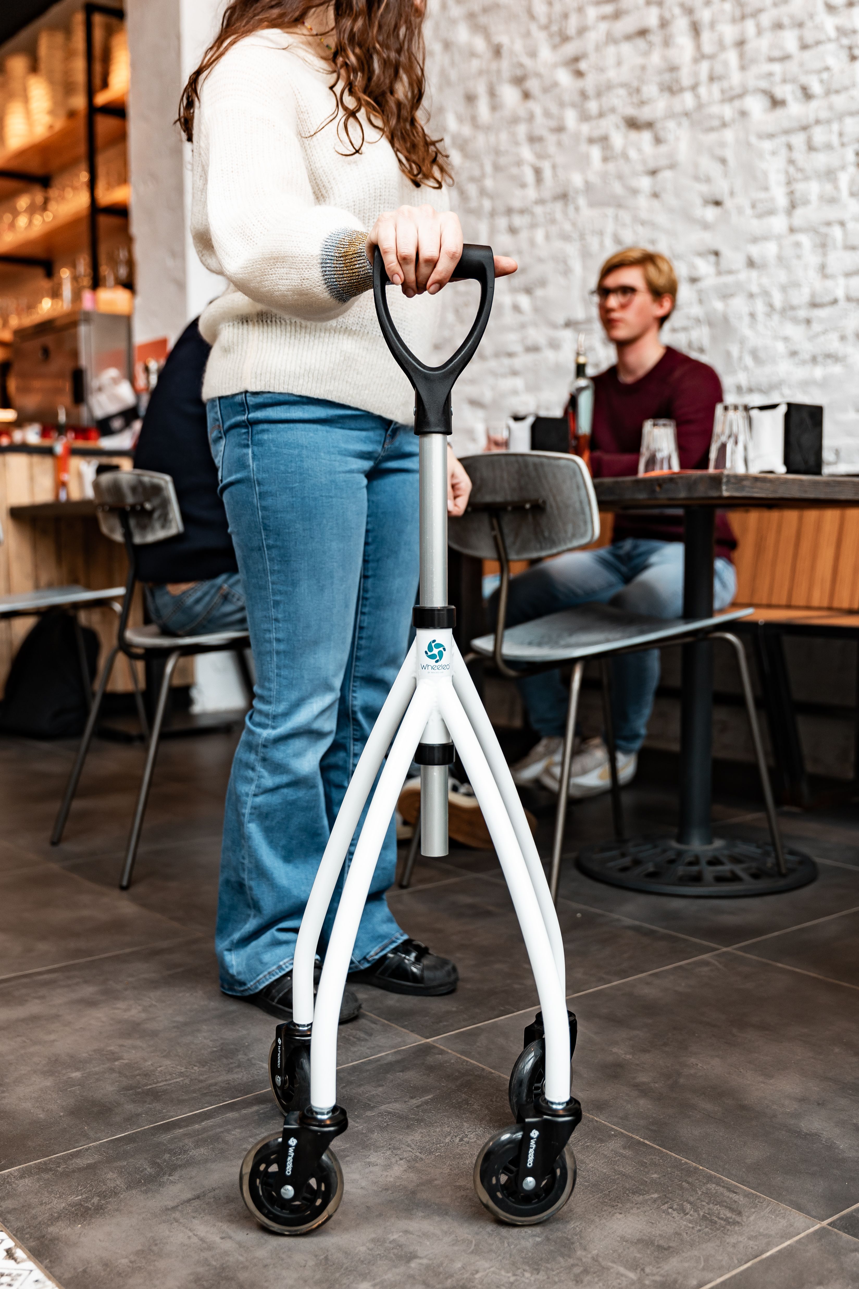 Person Using Rollator in a Modern Café Setting · Free Stock Photo