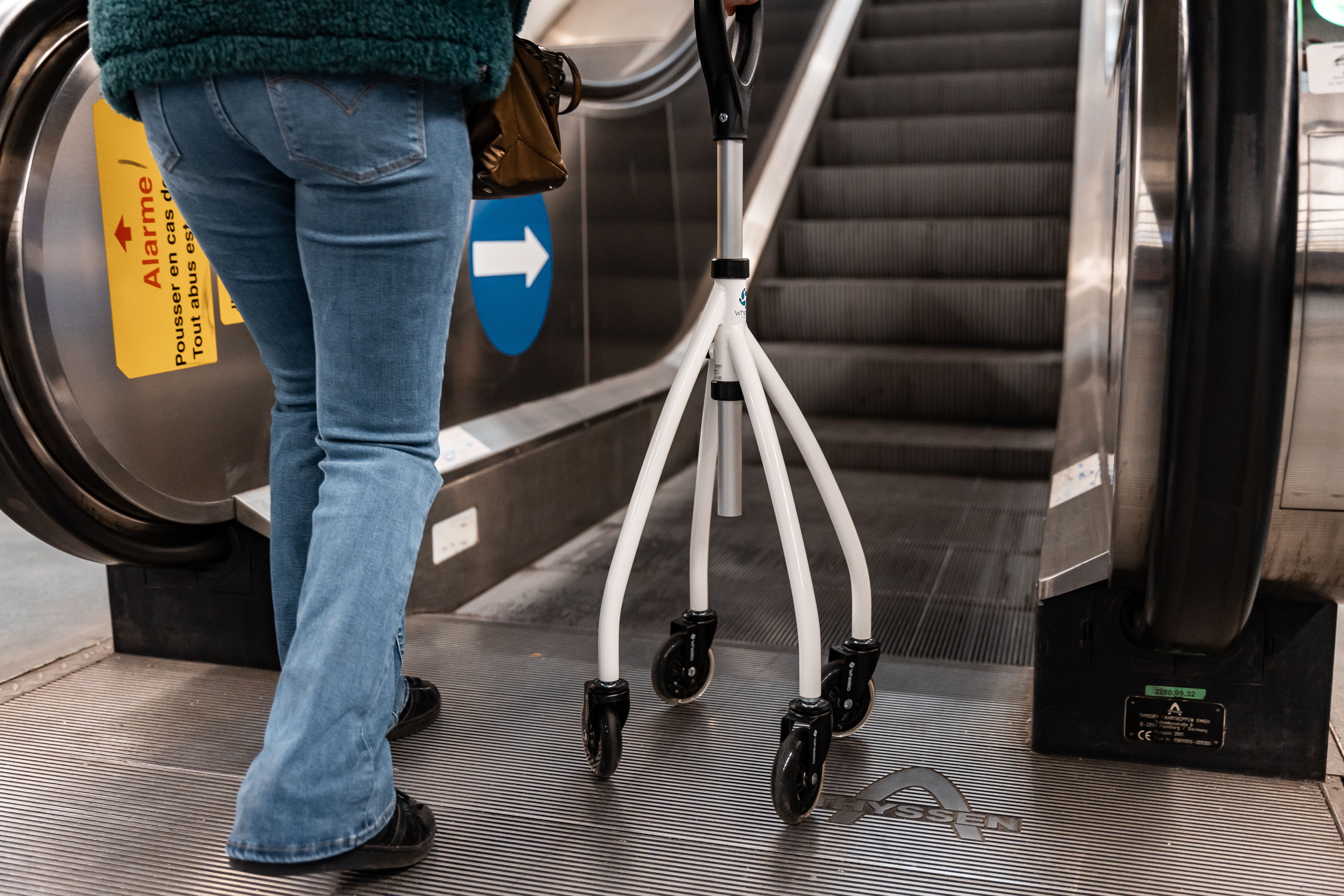 Person Using Rollator on Escalator in Urban Setting · Free Stock Photo