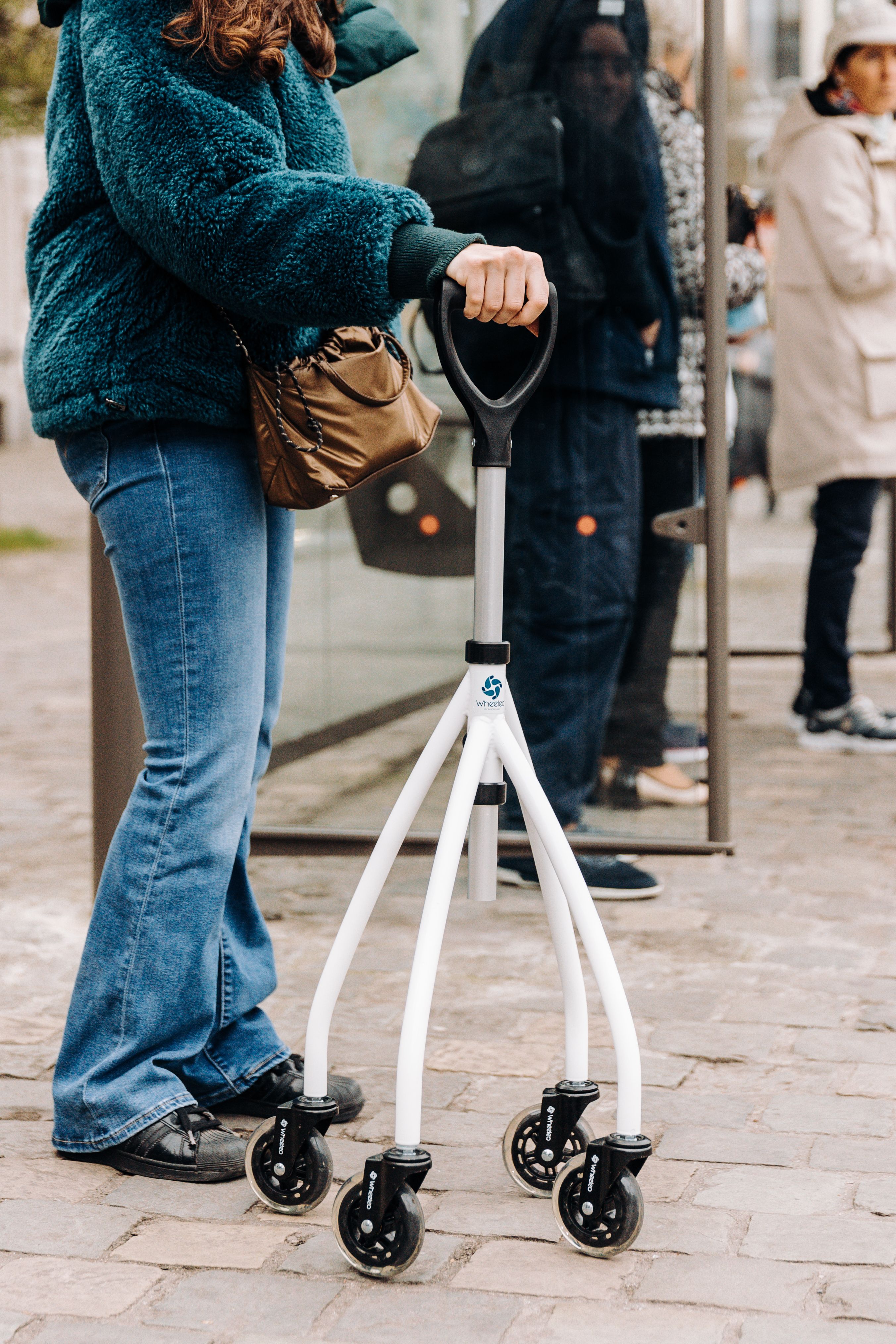 Person Waiting with Rollator at Bus Stop · Free Stock Photo
