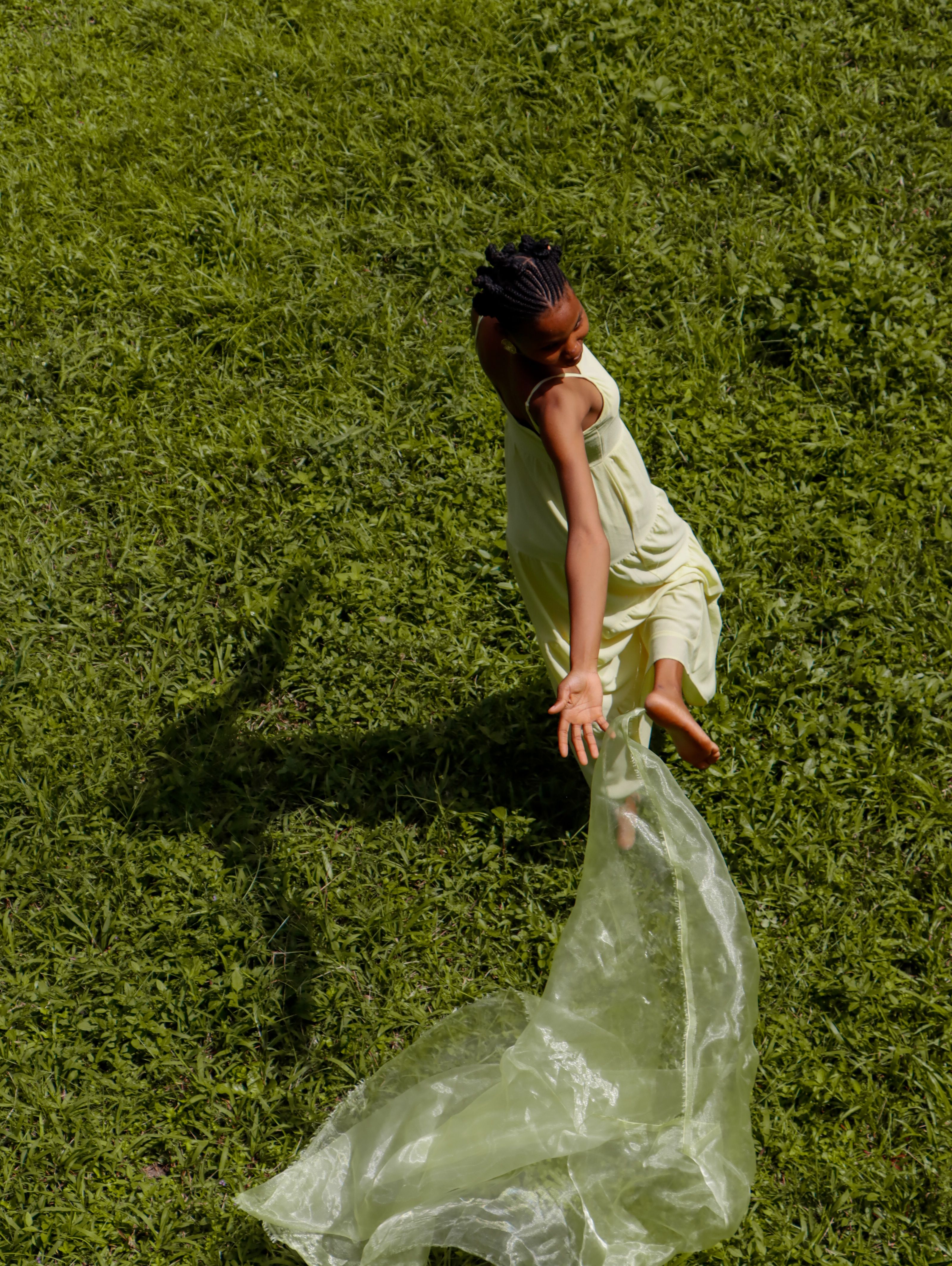 Elegant Woman in Flowing Green Dress on Grass · Free Stock Photo