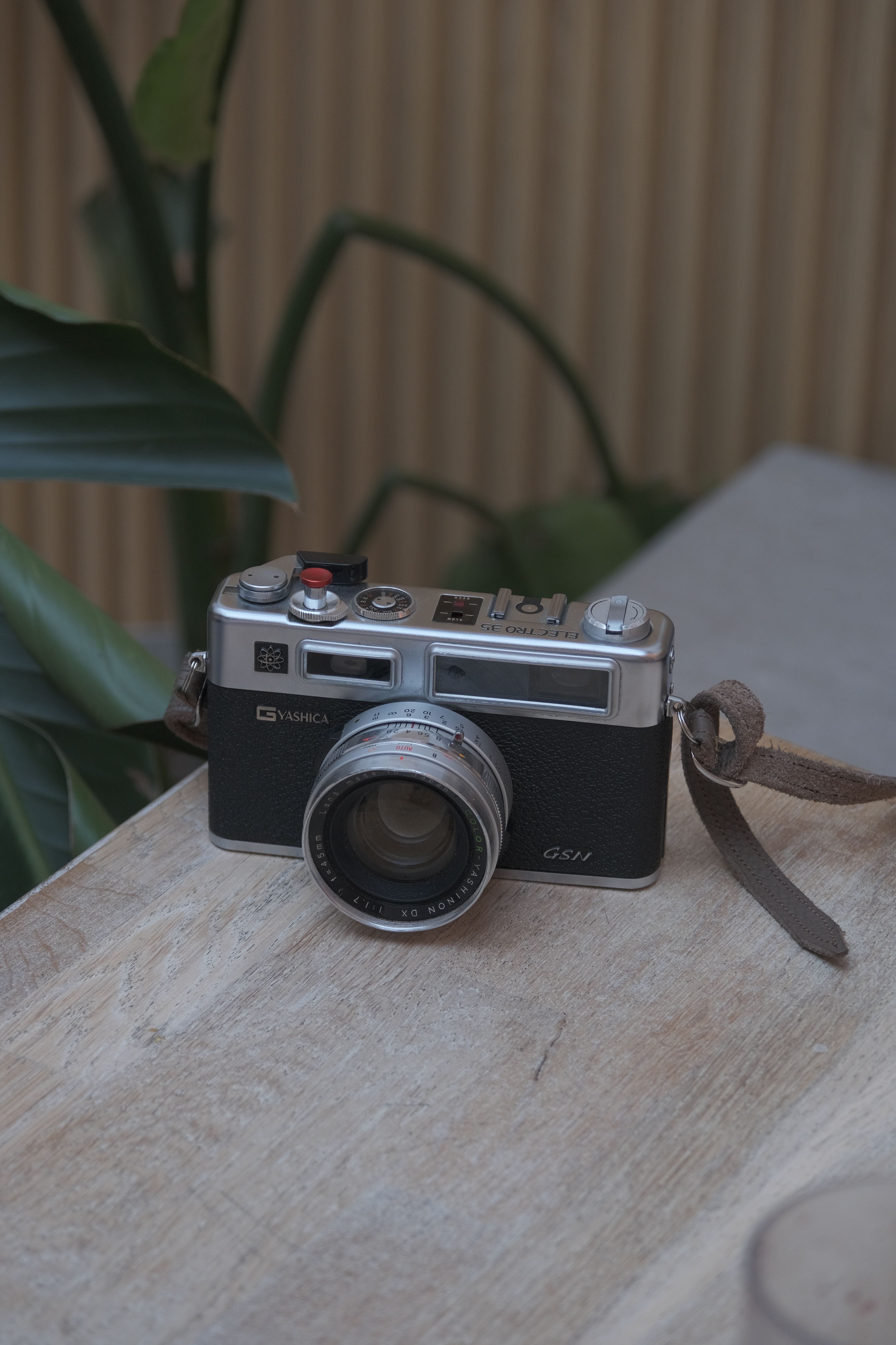 Vintage Film Camera on Wooden Table Indoors · Free Stock Photo
