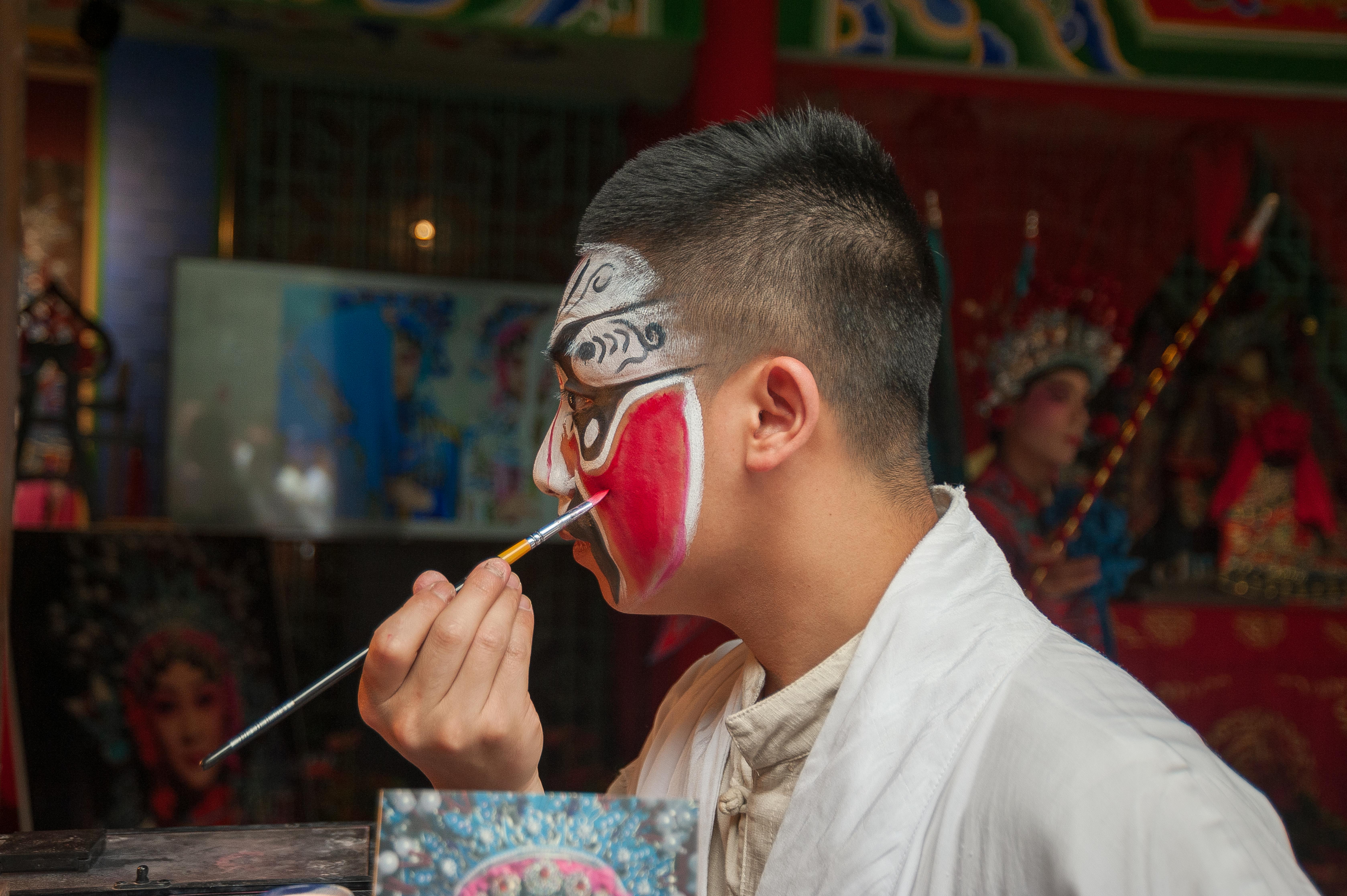 Traditional Chinese Opera Face Painting in Progress · Free Stock Photo