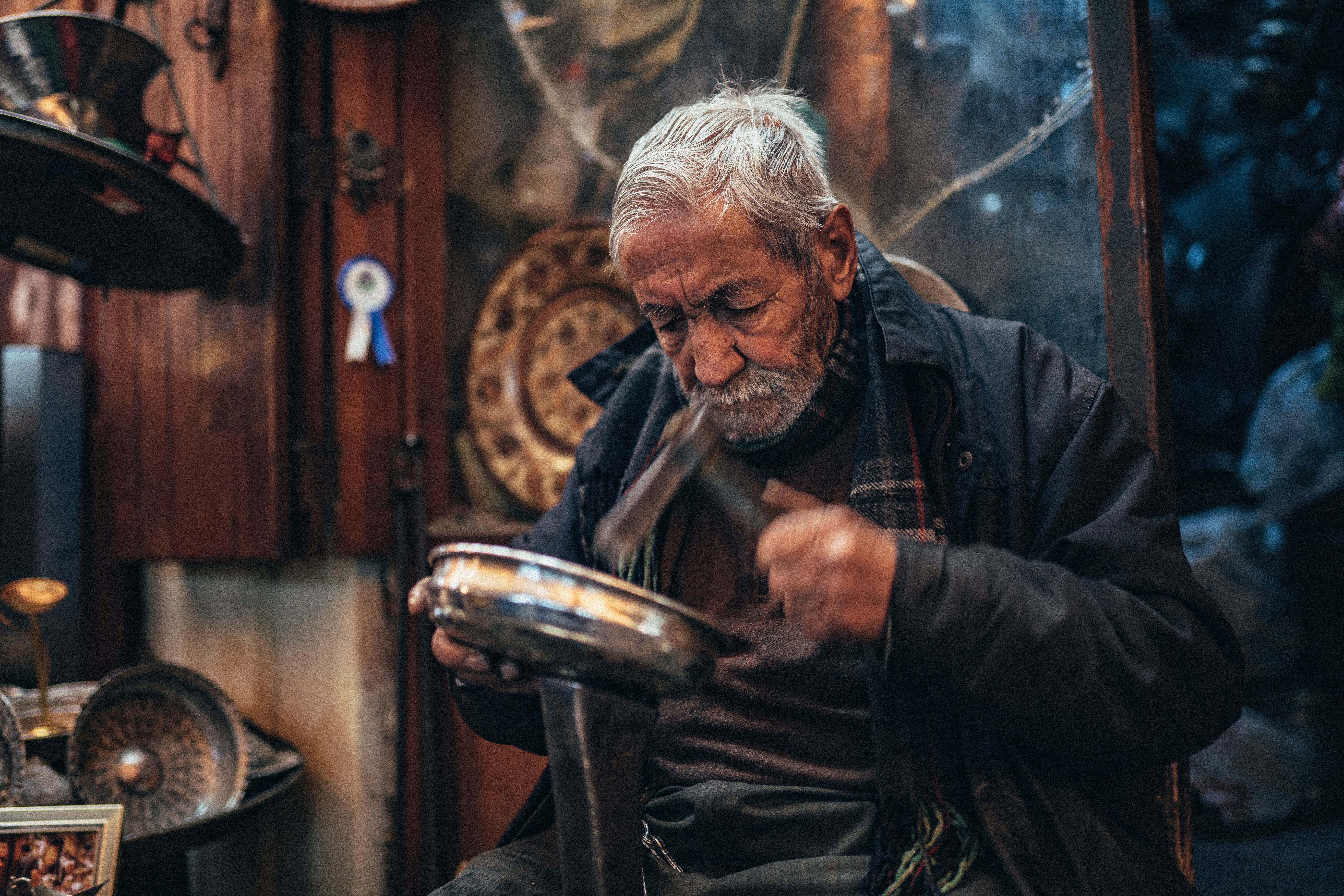 Elderly Craftsman at Work in Traditional Workshop · Free Stock Photo