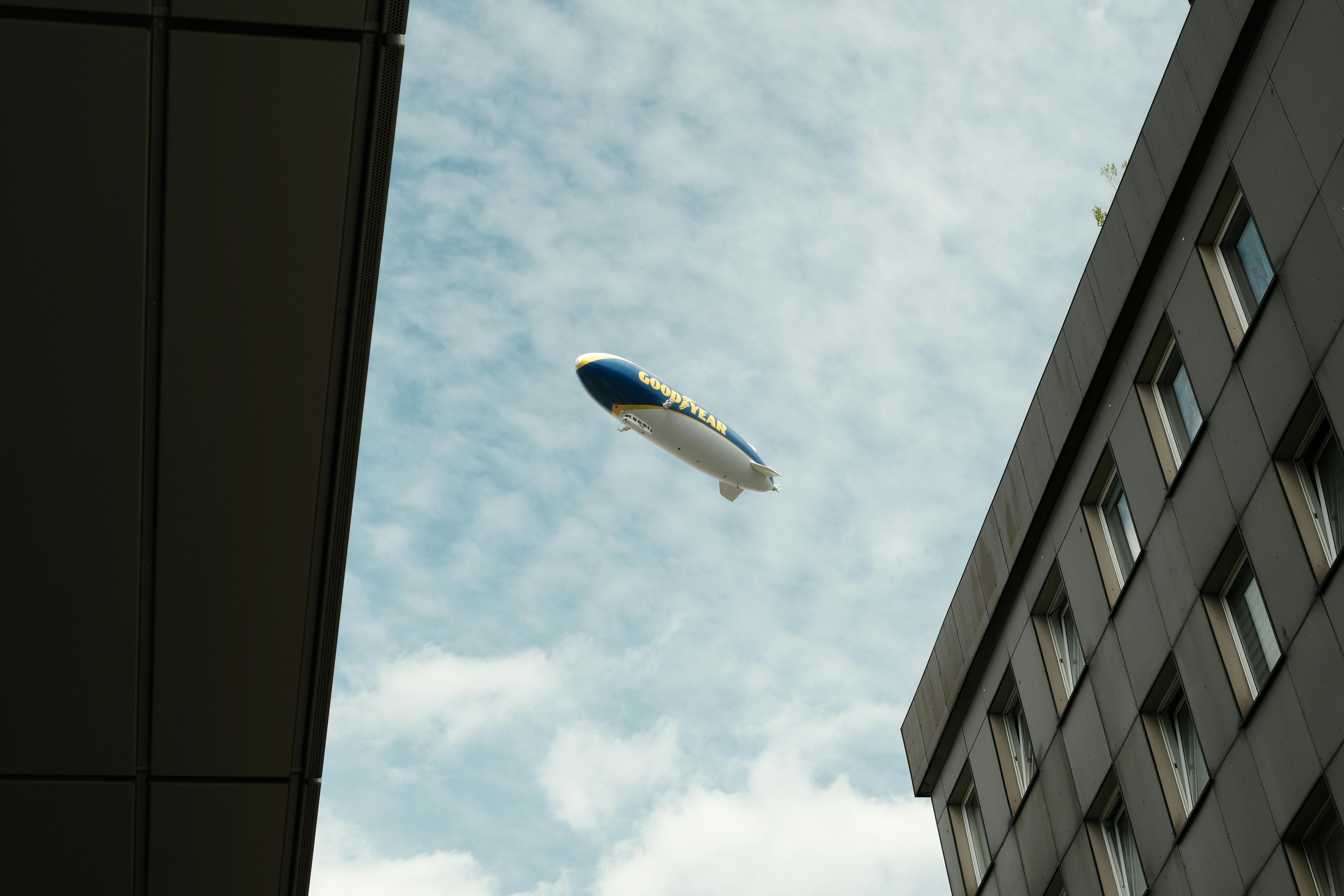 Goodyear Blimp Soaring Above German Cityscape · Free Stock Photo