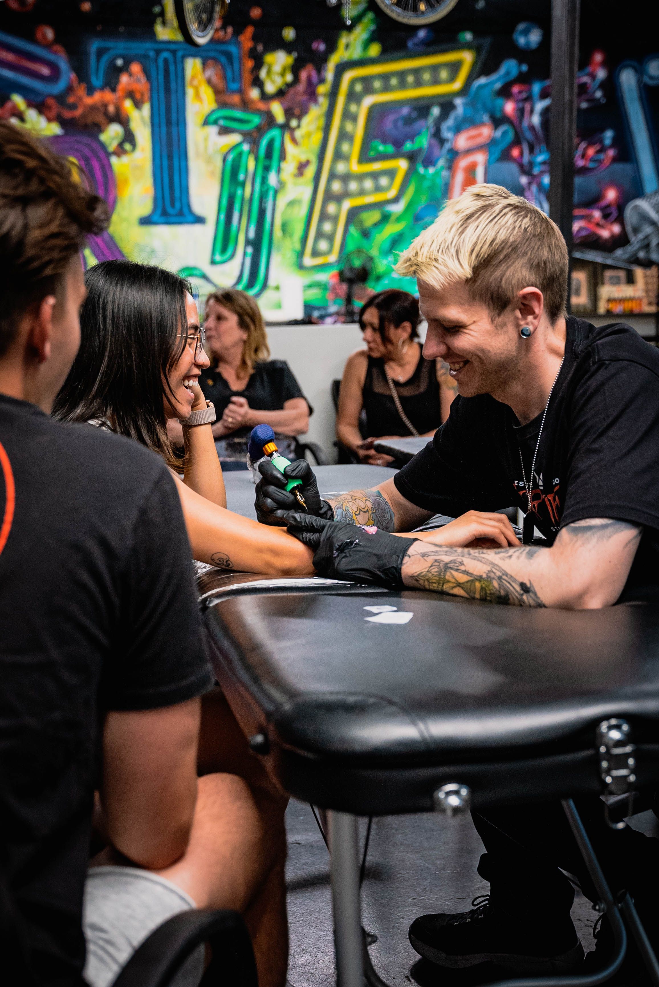 Dynamic Tattoo Session in Vibrant Studio Setting · Free Stock Photo