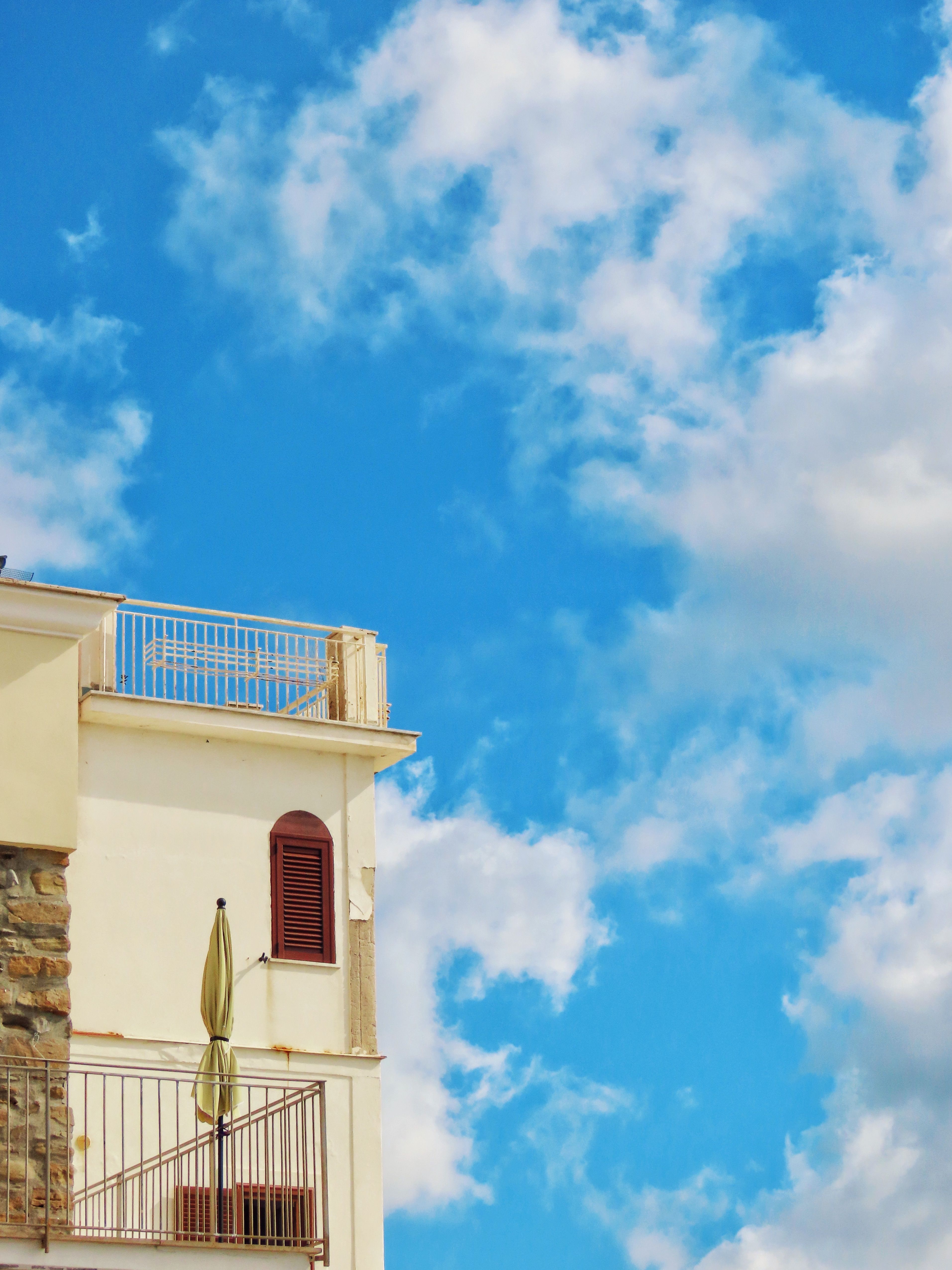 Mediterranean Building Against Blue Sky with Clouds · Free Stock Photo