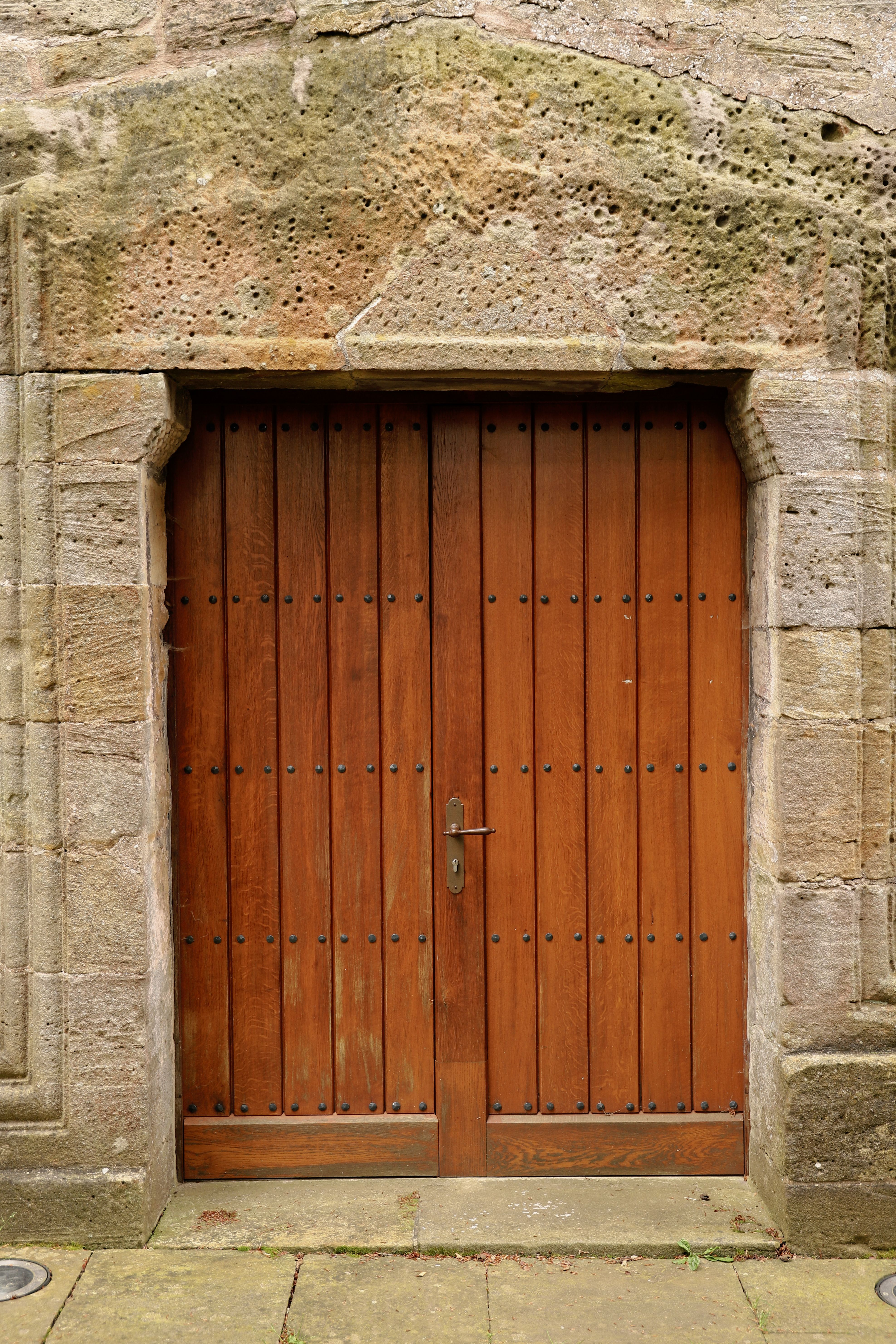Rustic Wooden Door with Stone Frame Entrance · Free Stock Photo