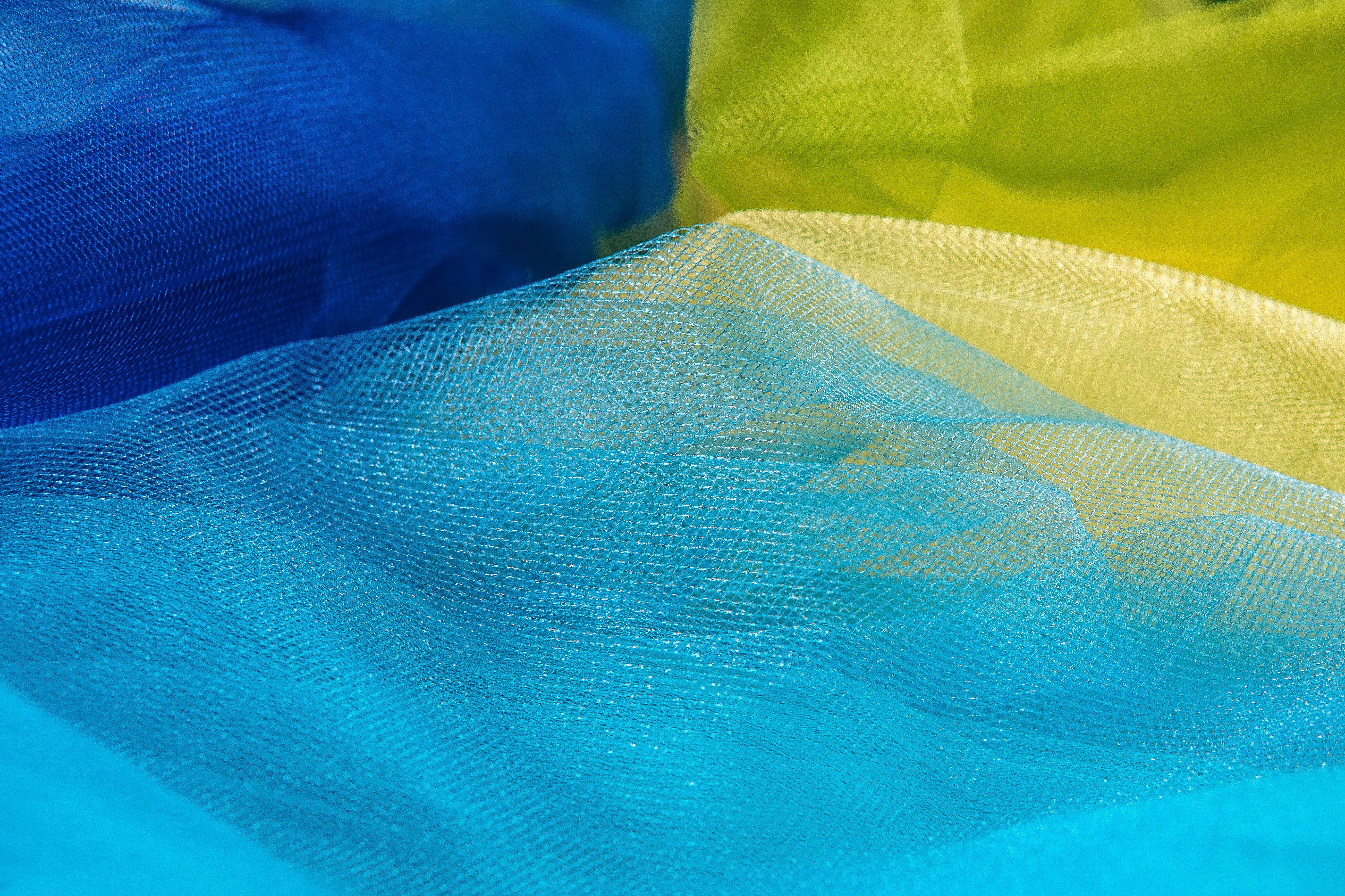 Vibrant Blue and Yellow Mesh Fabric Close-up · Free Stock Photo