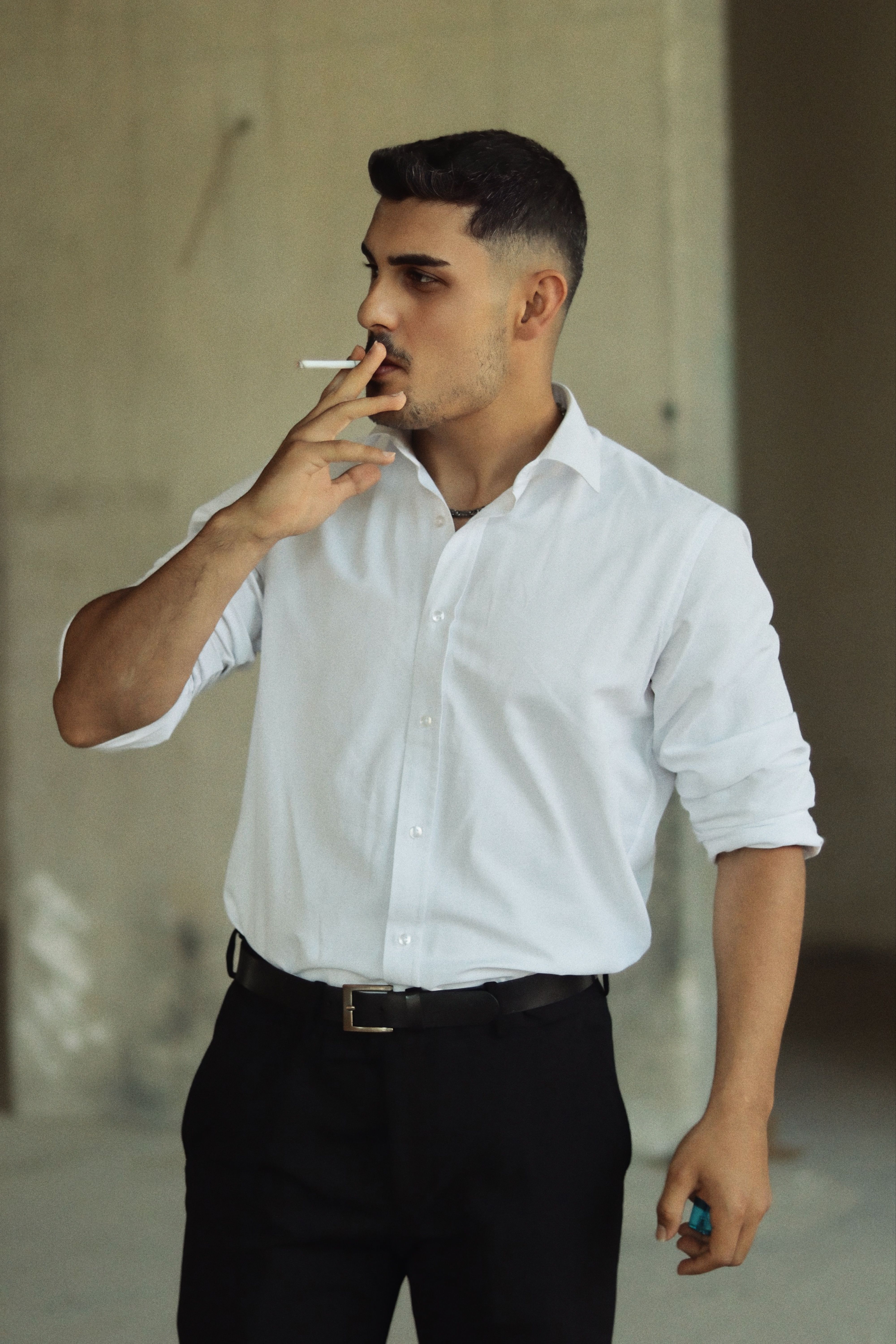 Man Smoking Cigarette Indoors in Stylish Outfit · Free Stock Photo