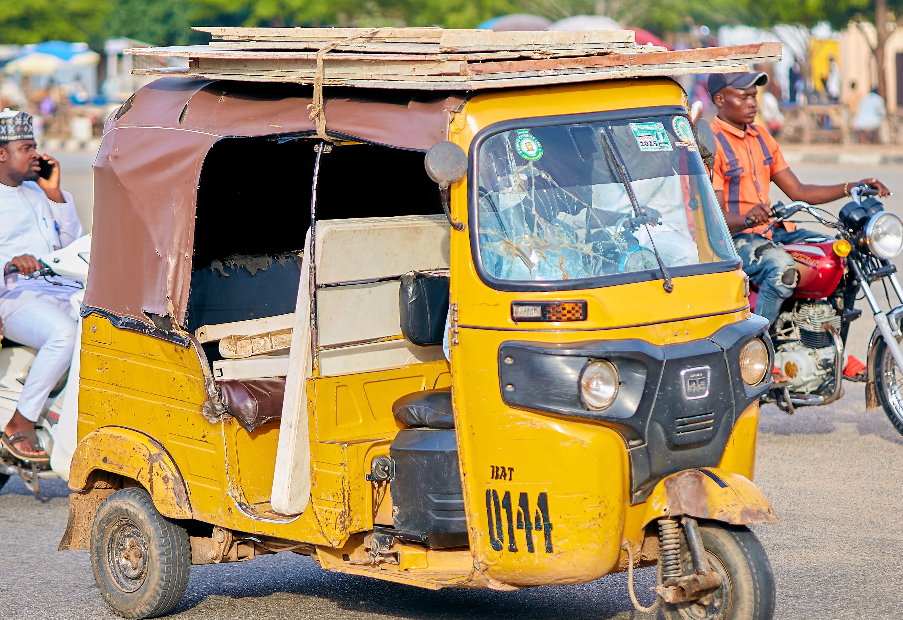 Bright Yellow Auto Rickshaw on City Street · Free Stock Photo