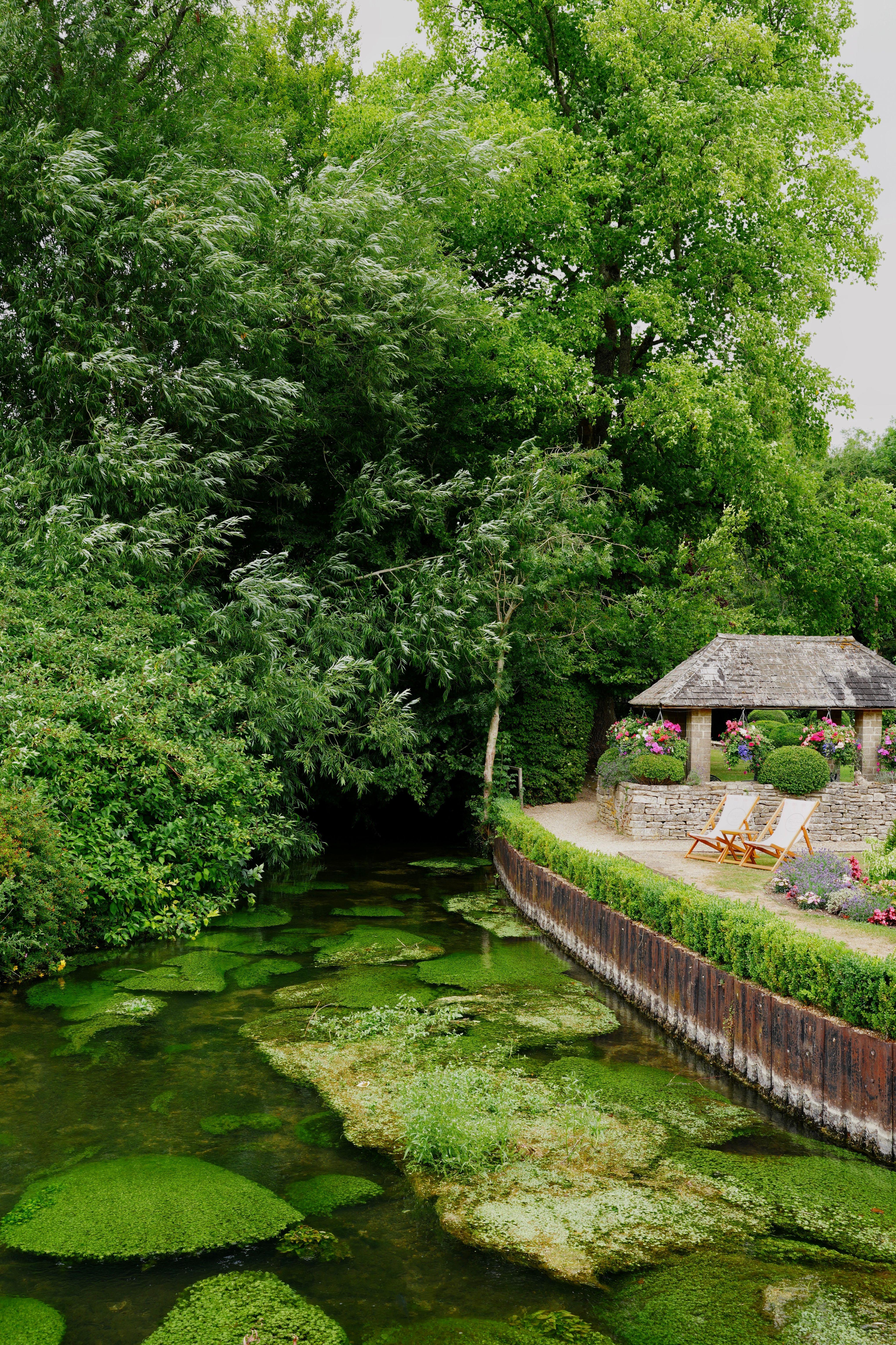 Charming Stone Cottage by a Lush Green Stream · Free Stock Photo