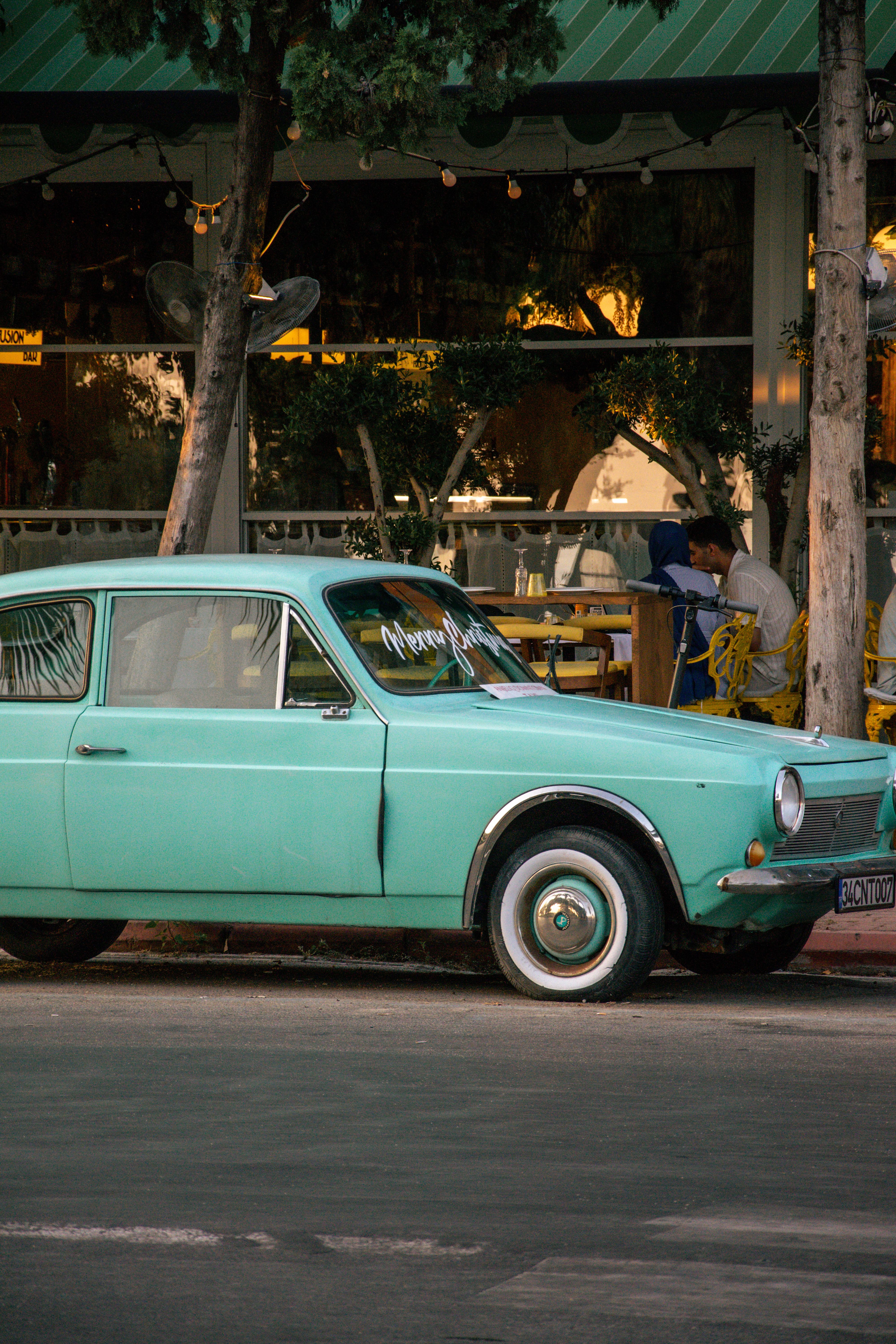 Vintage Car Parked in Front of a Turkish Cafe · Free Stock Photo