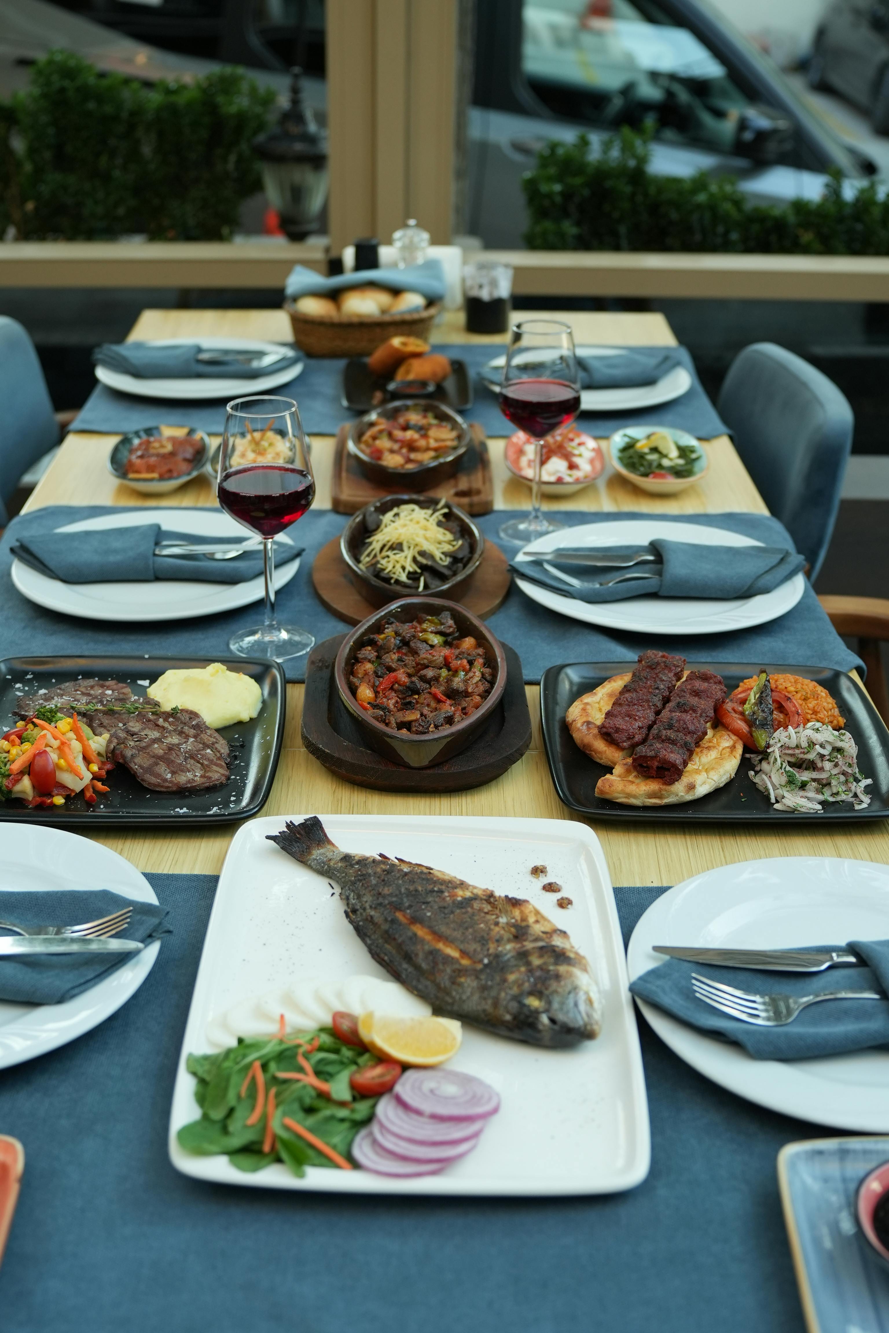 Elegant Fine Dining Table Set with Diverse Dishes · Free Stock Photo