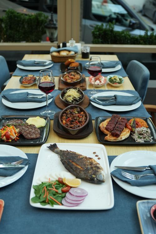 Elegant Fine Dining Table Set with Diverse Dishes · Free Stock Photo