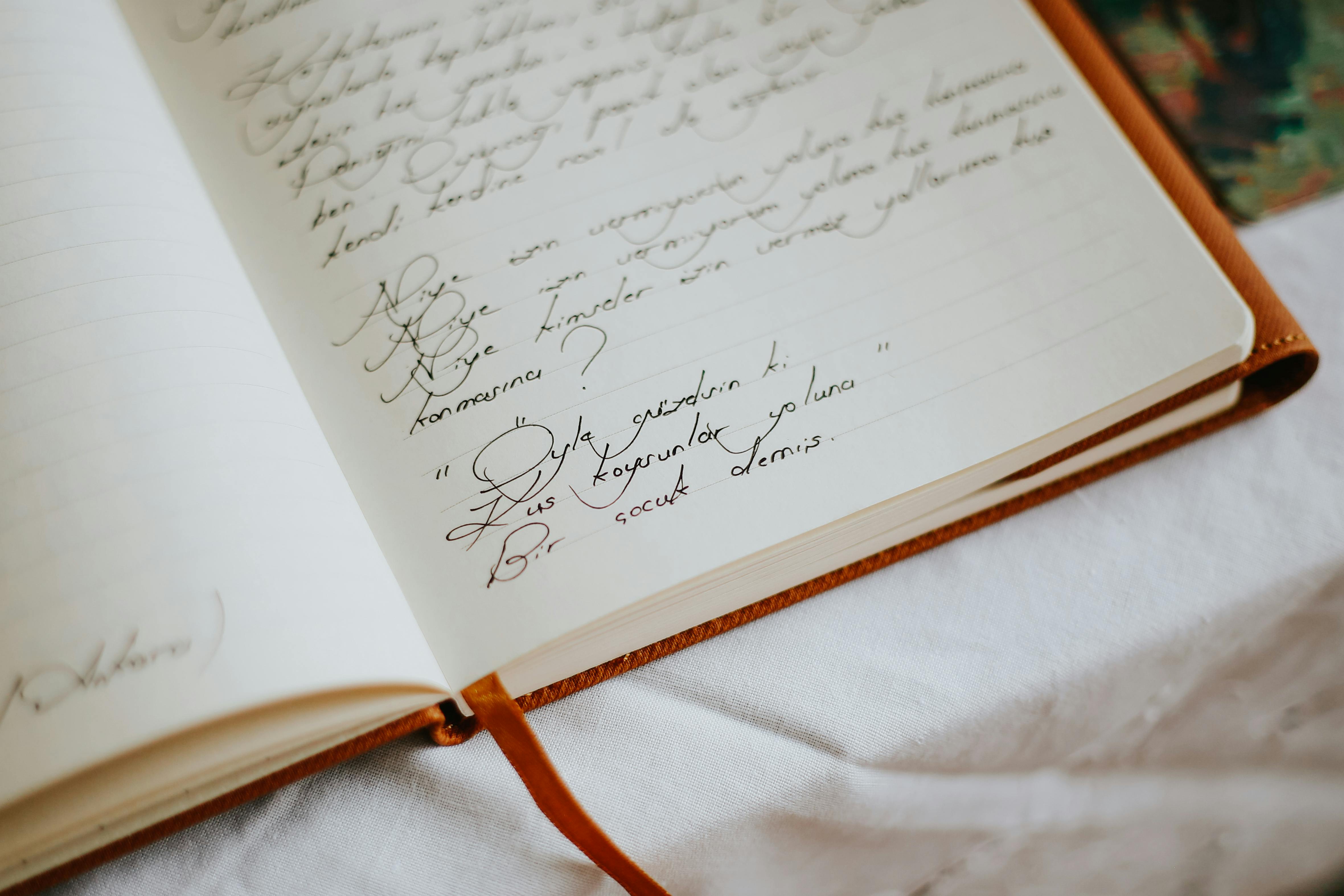Elegant Handwritten Journal on White Linen · Free Stock Photo