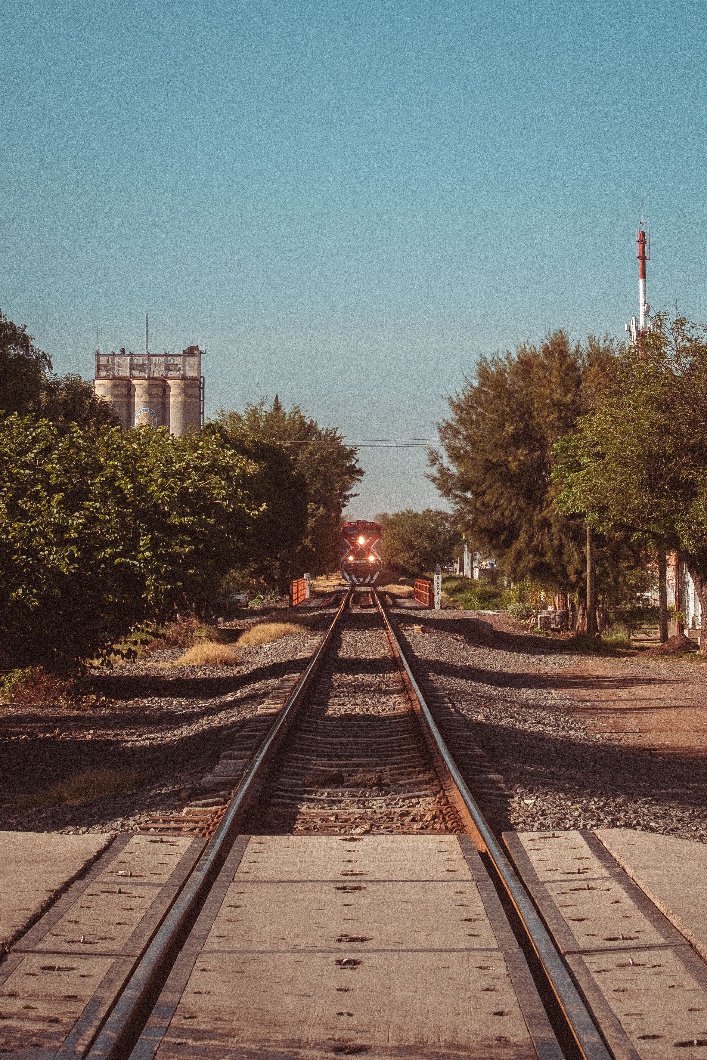 Scenic Railroad Tracks with Train Approaching · Free Stock Photo