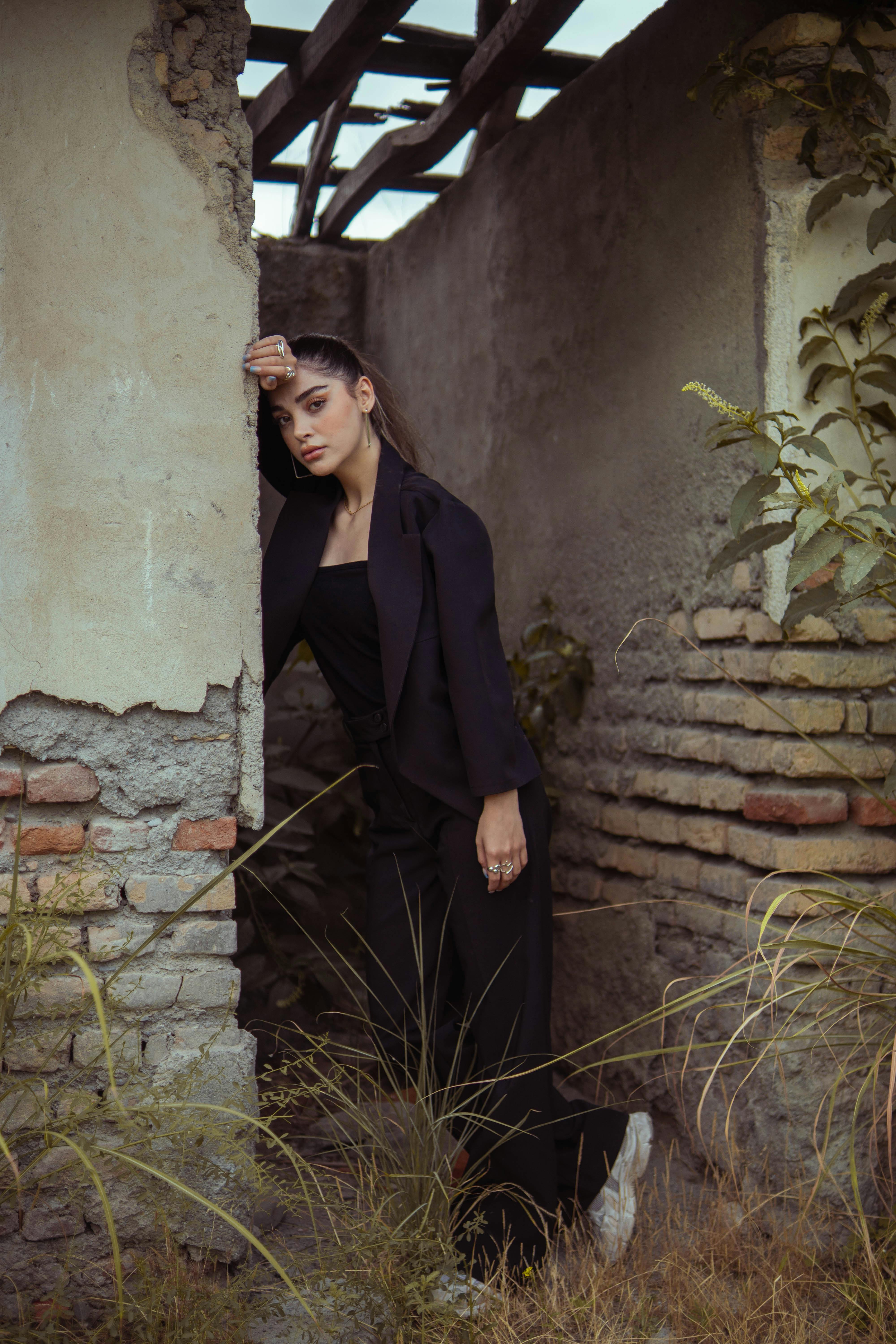 Stylish Woman Posing in Rustic Ruins · Free Stock Photo