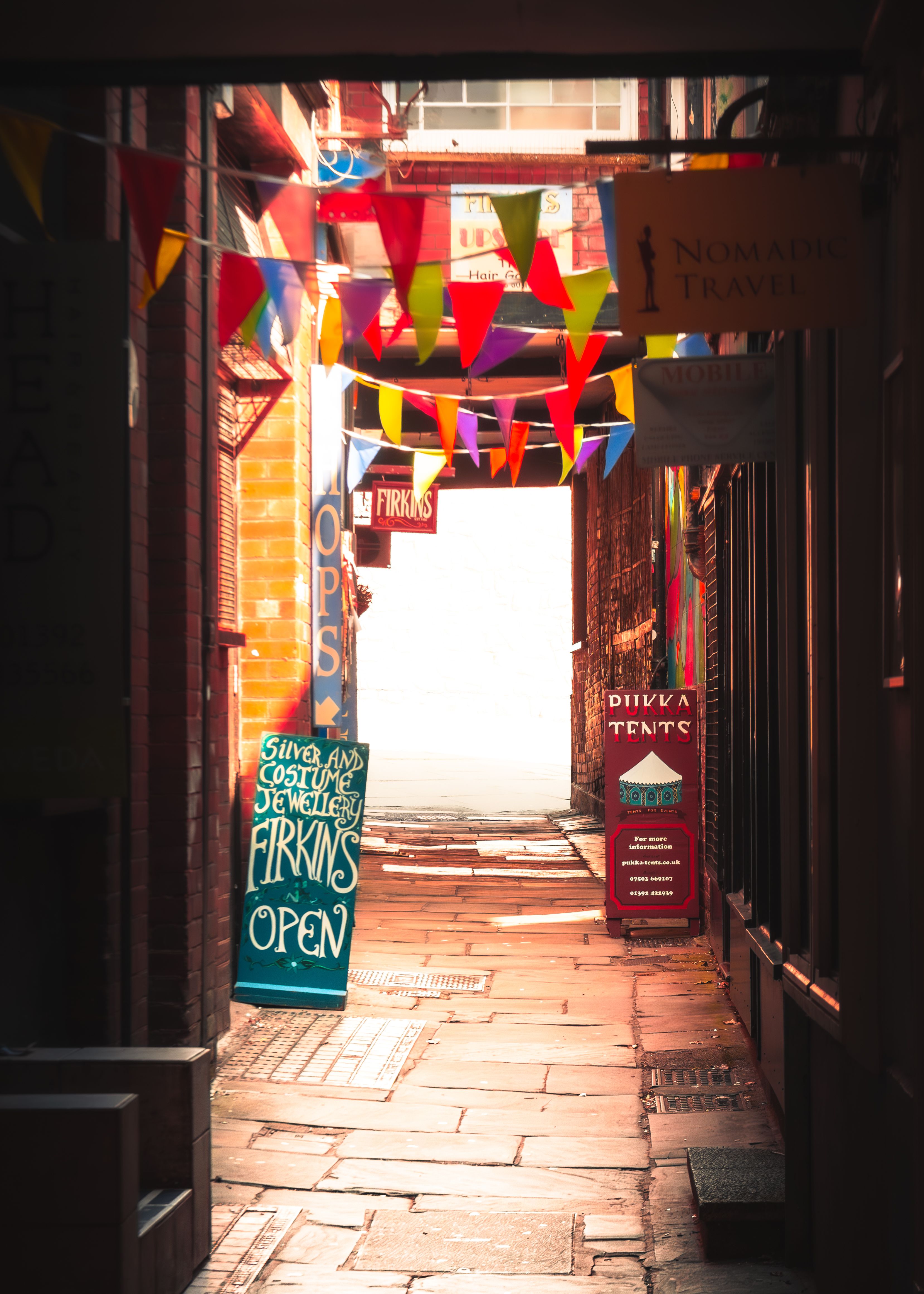 Colorful Alleyway with Bunting and Signage · Free Stock Photo