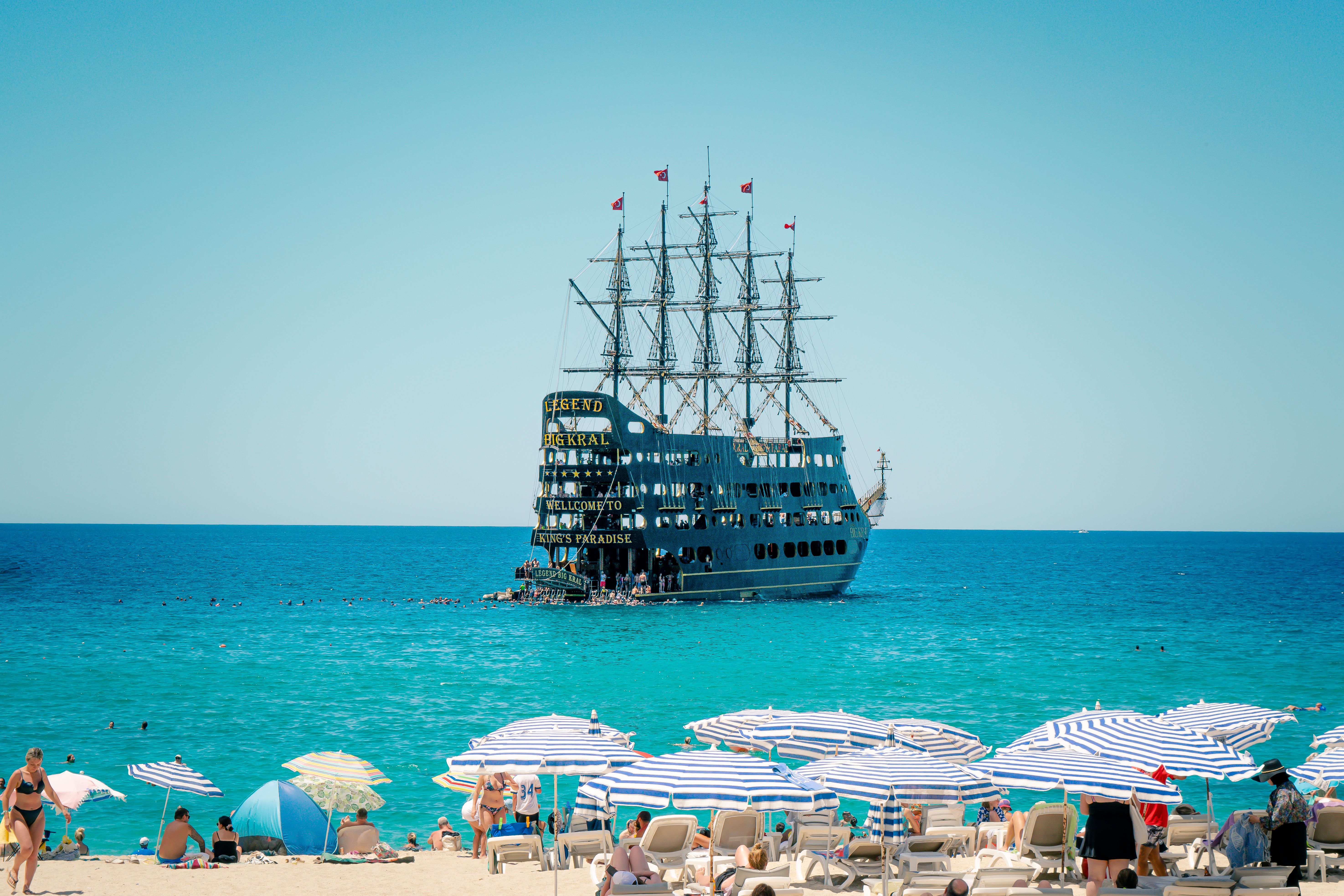 Scenic Alanya Beach with Pirate Ship on Blue Waters · Free Stock Photo