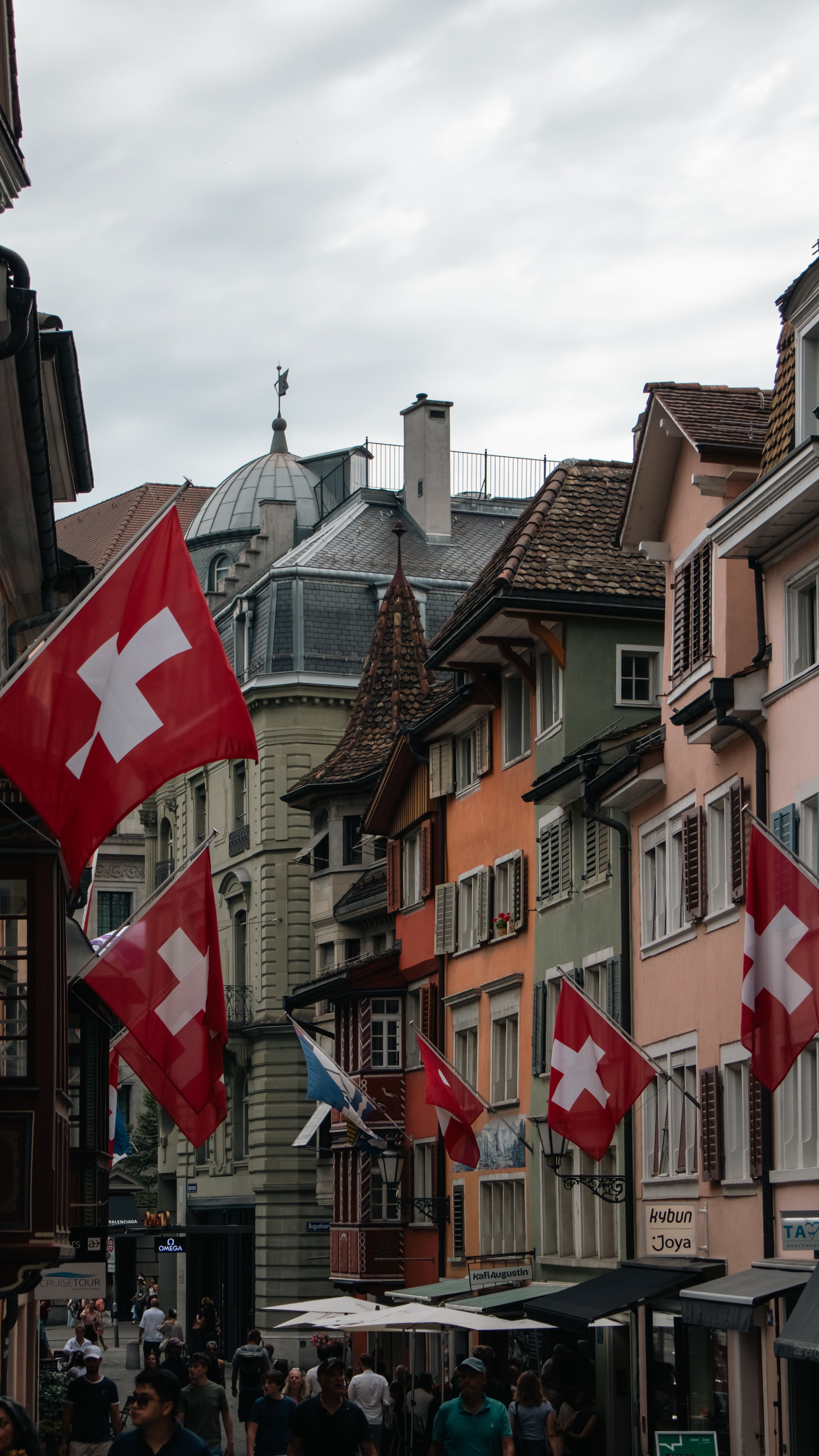 Charming Zurich Street with Swiss Flags Displayed · Free Stock Photo