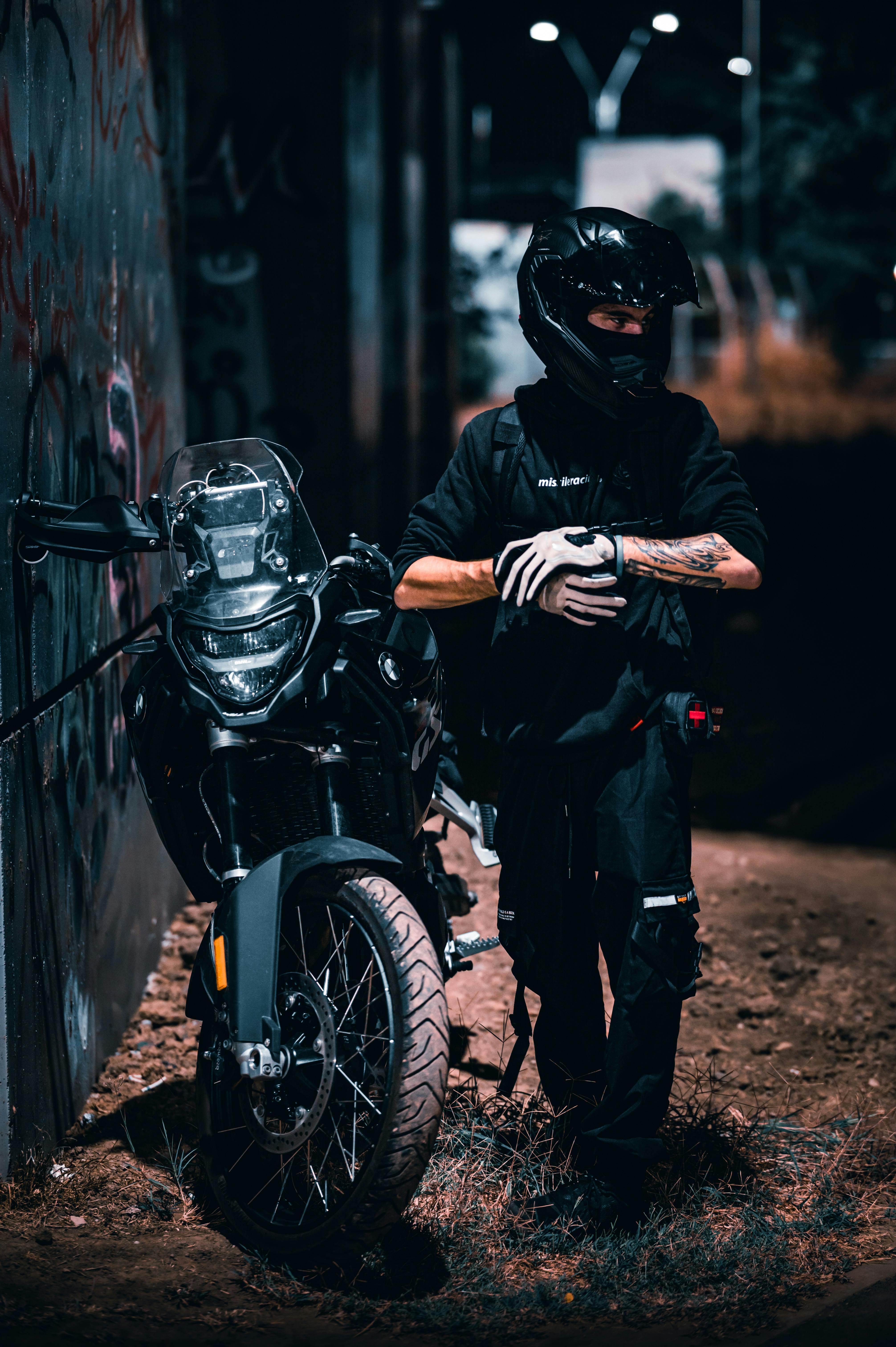 Motorcyclist in Gear Standing by Motorbike at Night · Free Stock Photo
