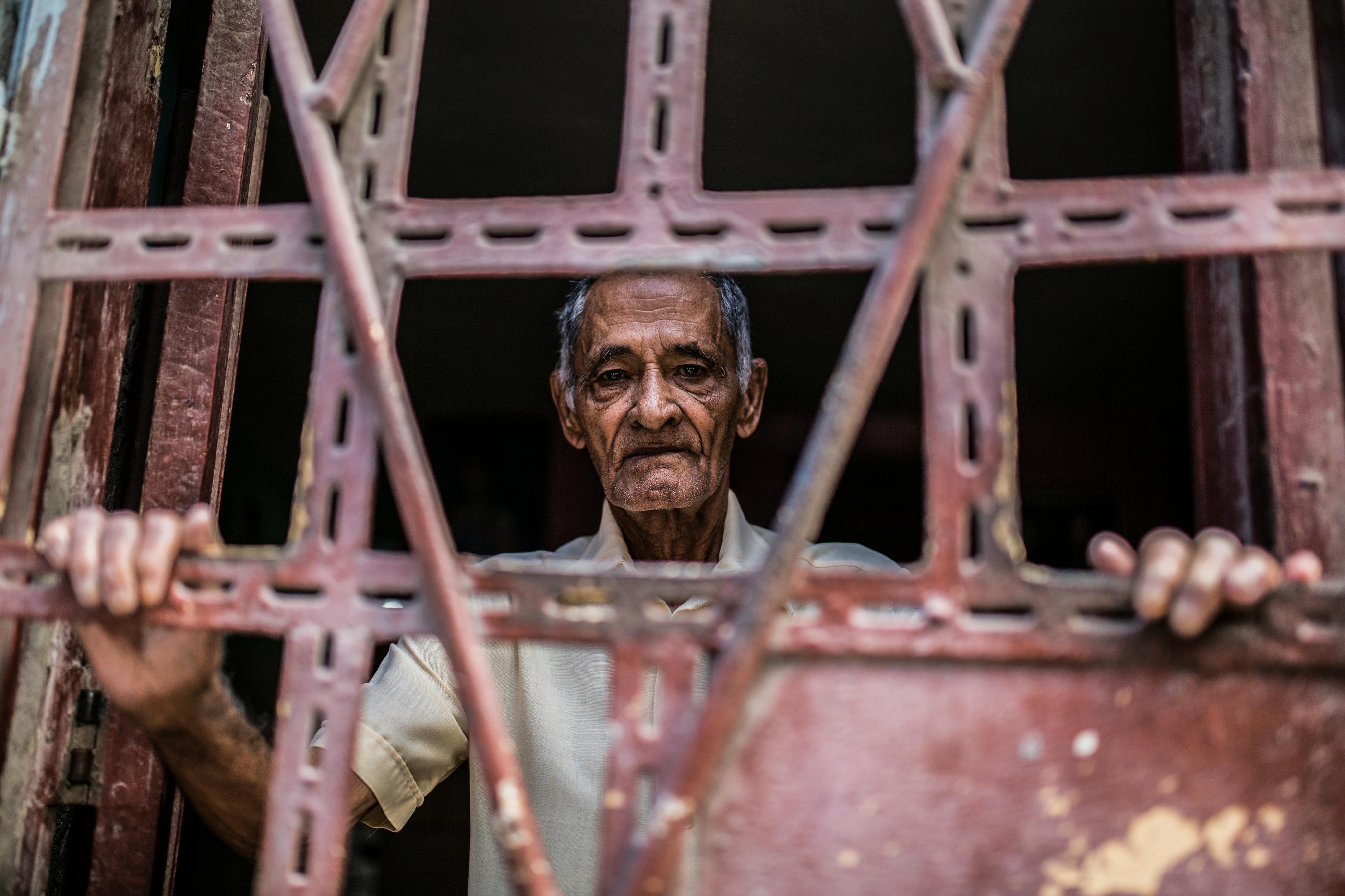 Elderly Man Behind Barred Window in Havana · Free Stock Photo