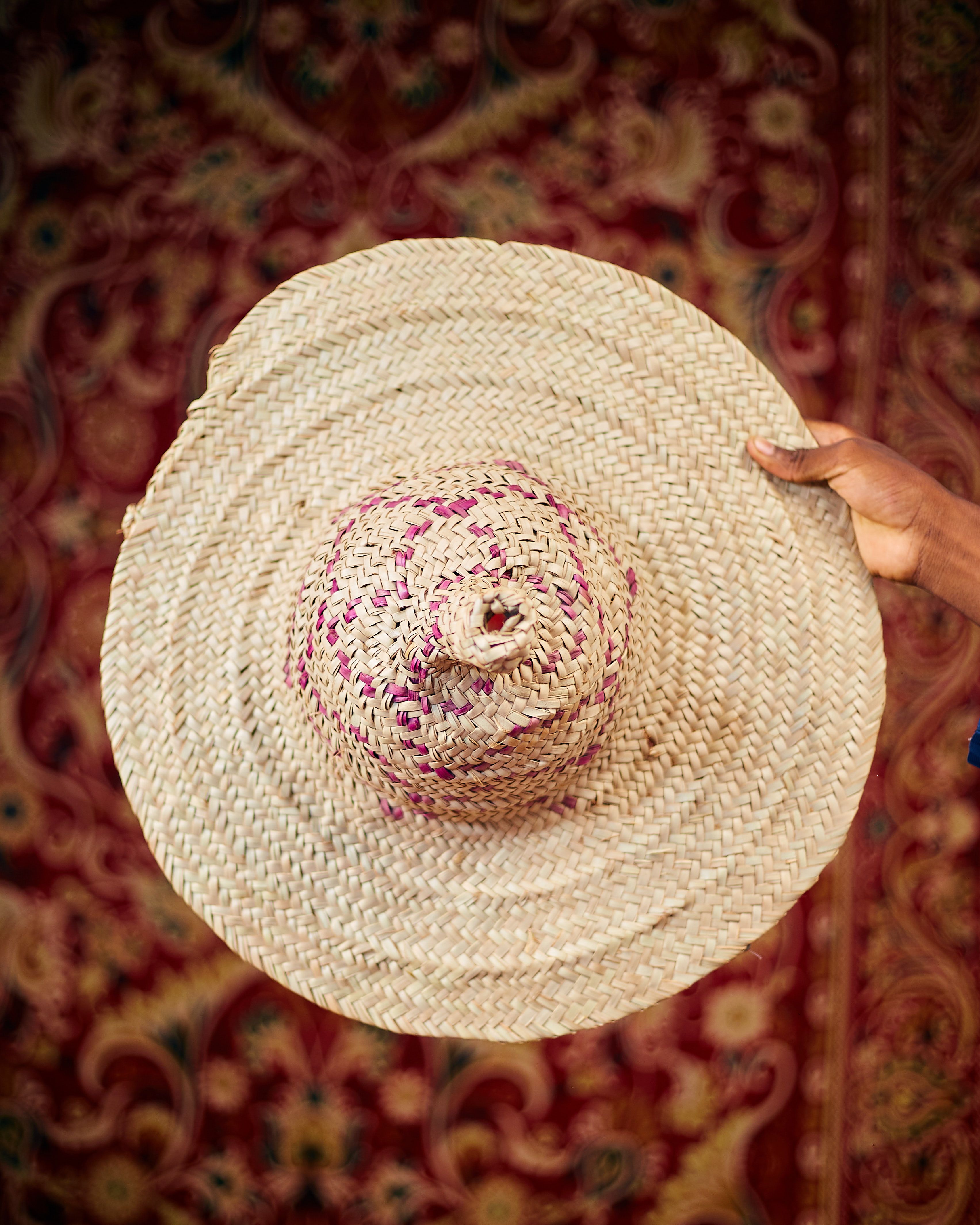 Traditional Woven Straw Hat on Ornate Background · Free Stock Photo