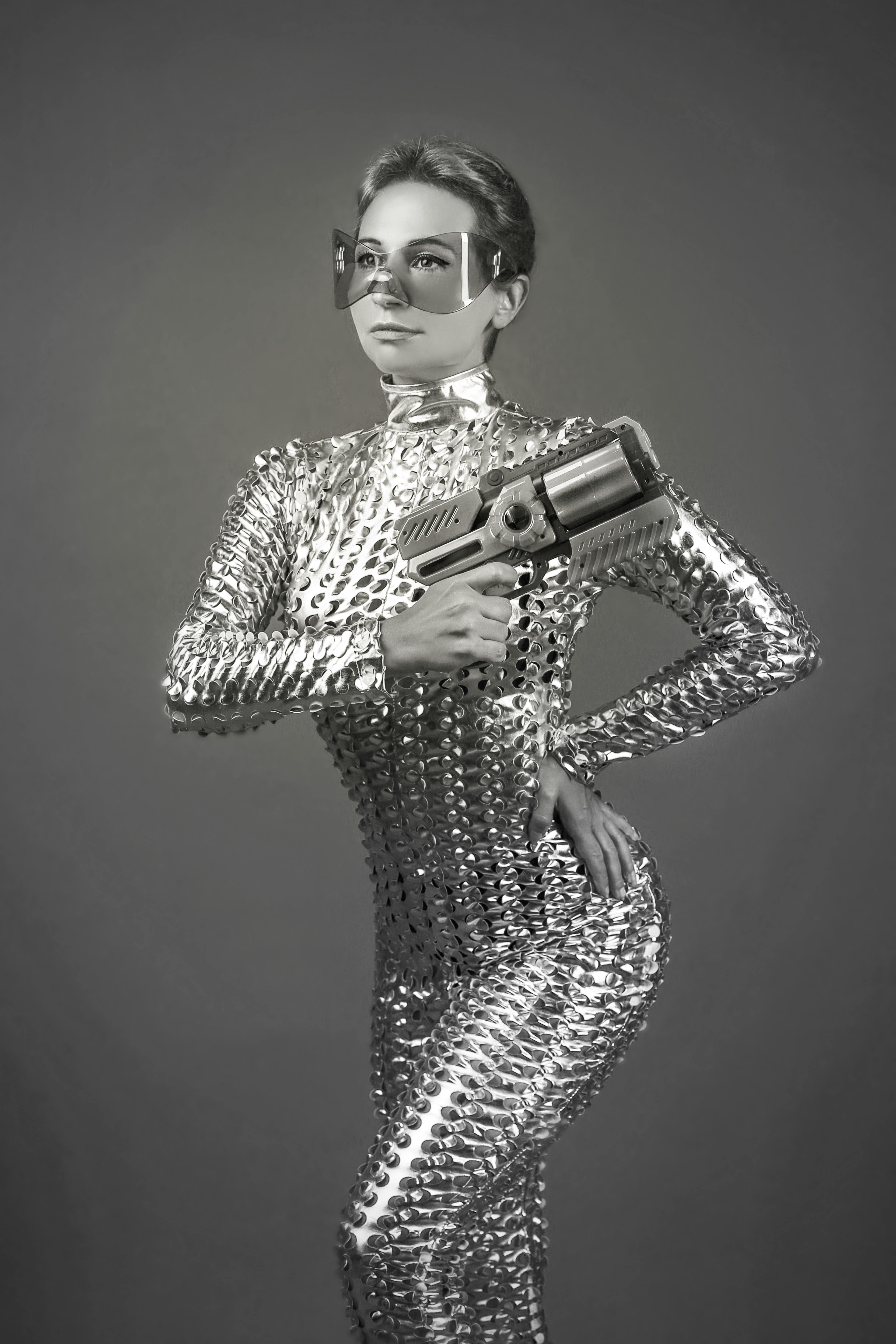 Woman in a Costume and Mask Holding a Weapon · Free Stock Photo