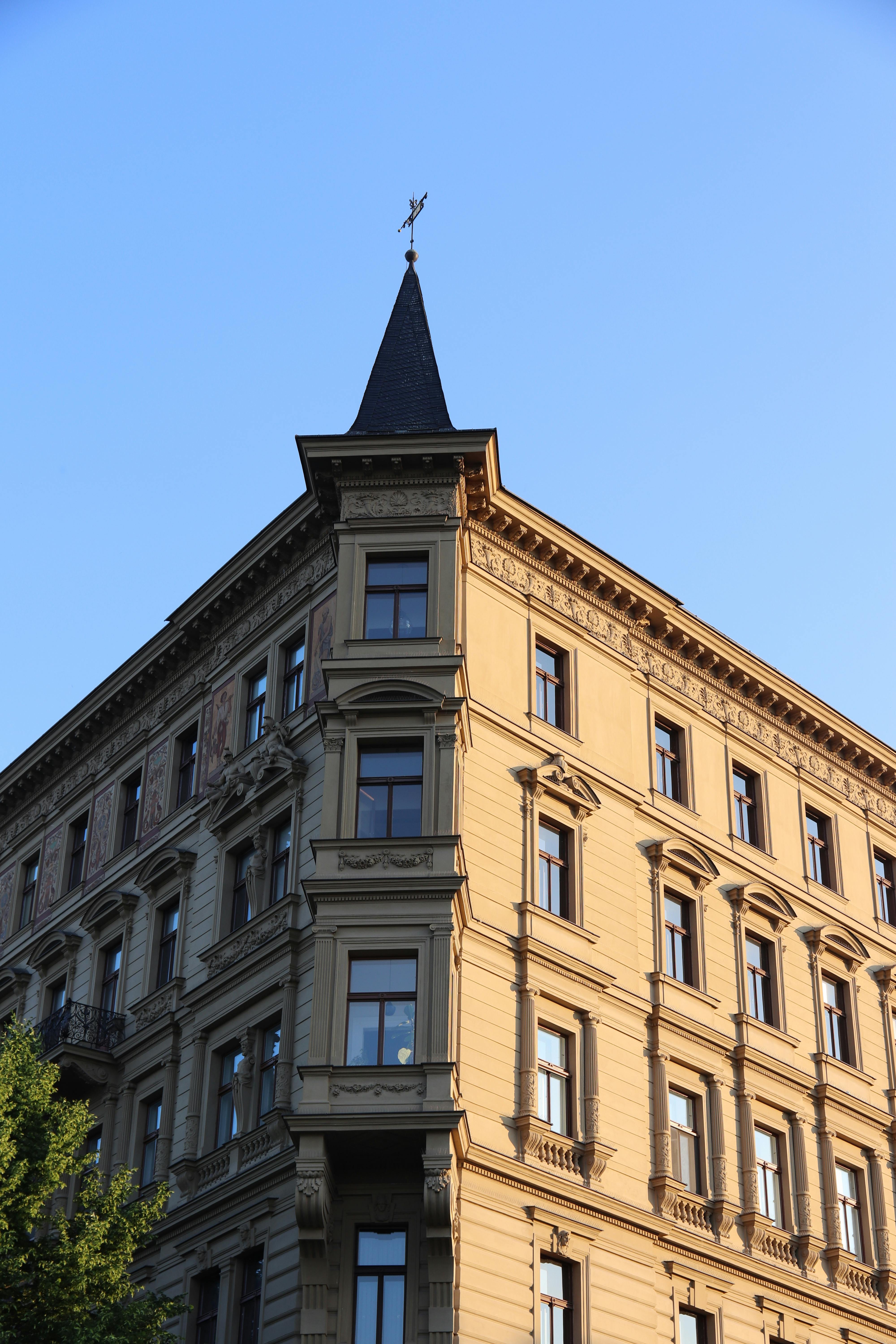 Historic European Building with Sharp Spire · Free Stock Photo