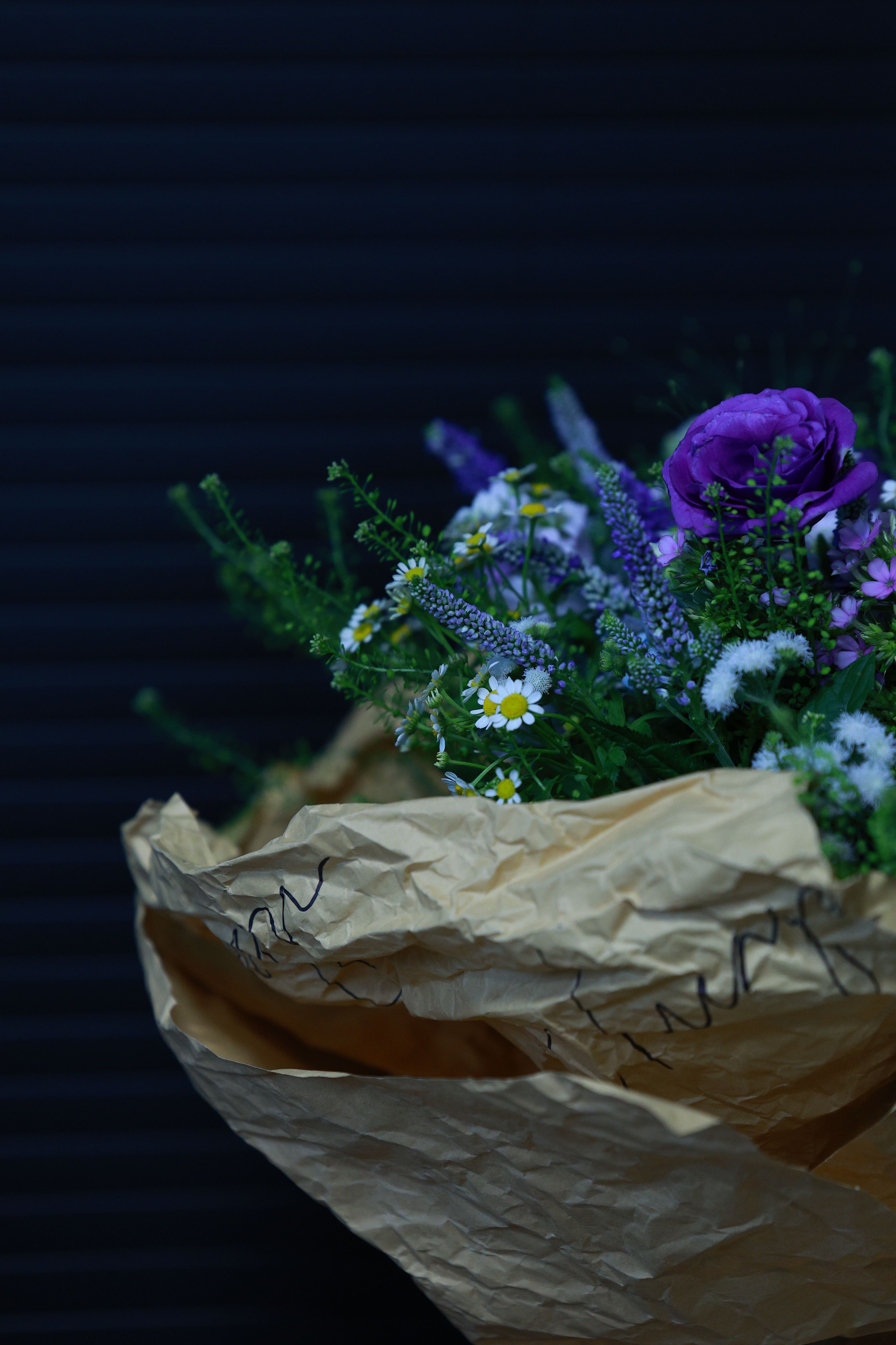 Vibrant Floral Bouquet Wrapped in Crumpled Paper · Free Stock Photo