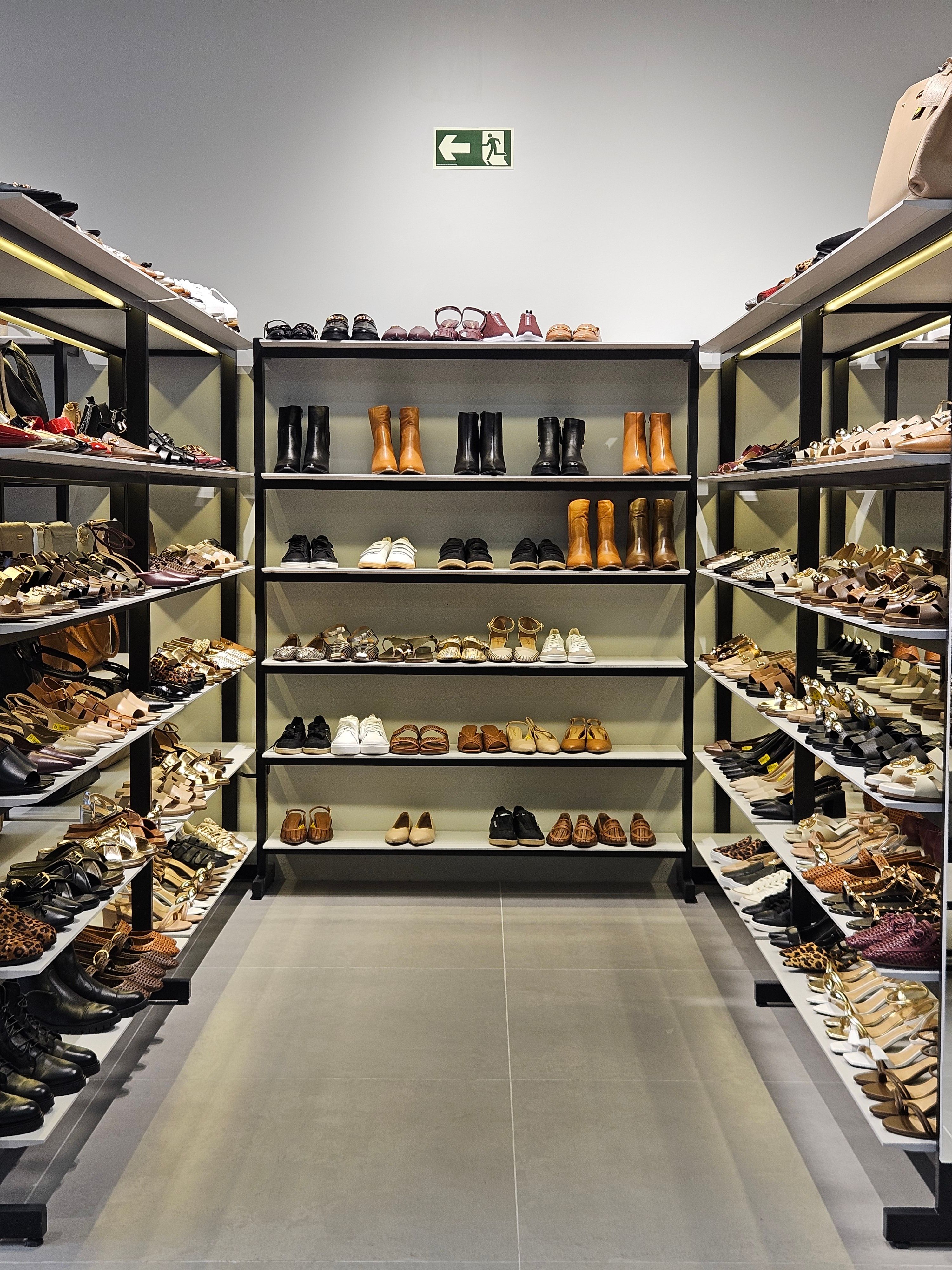 Shoe Store Aisle with Diverse Footwear Collection · Free Stock Photo