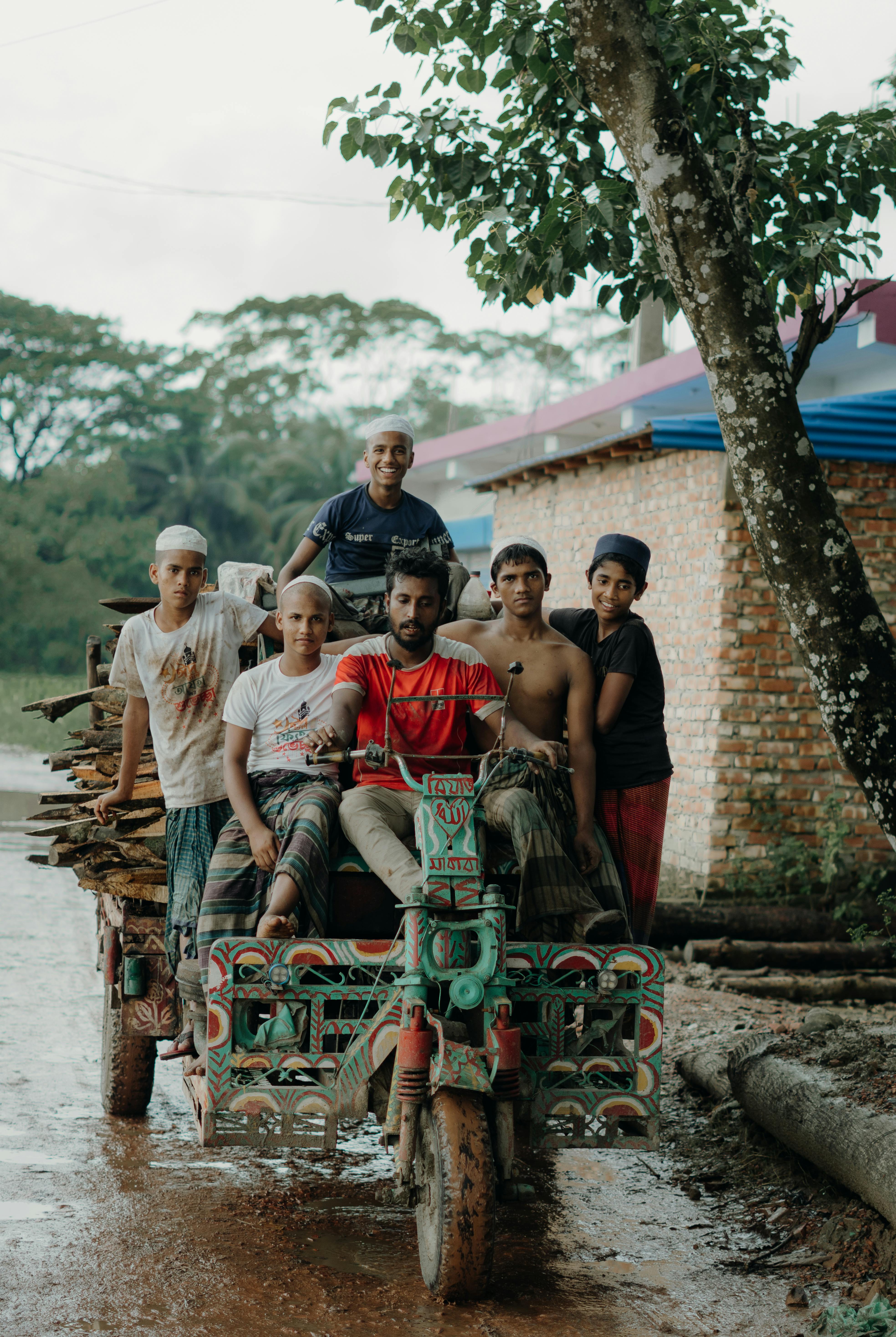 Group of People on a Rustic Cargo Tricycle · Free Stock Photo