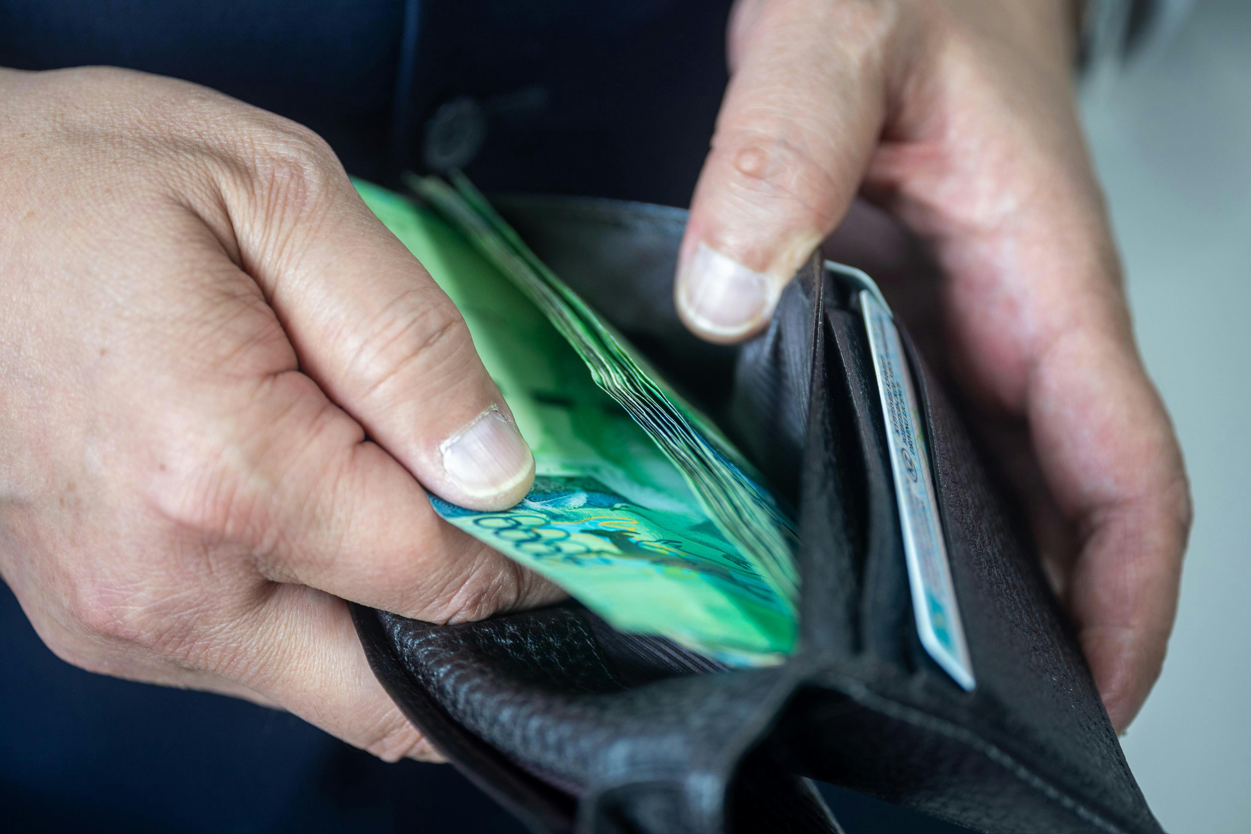 Man Looking at an Empty Wallet · Free Stock Photo