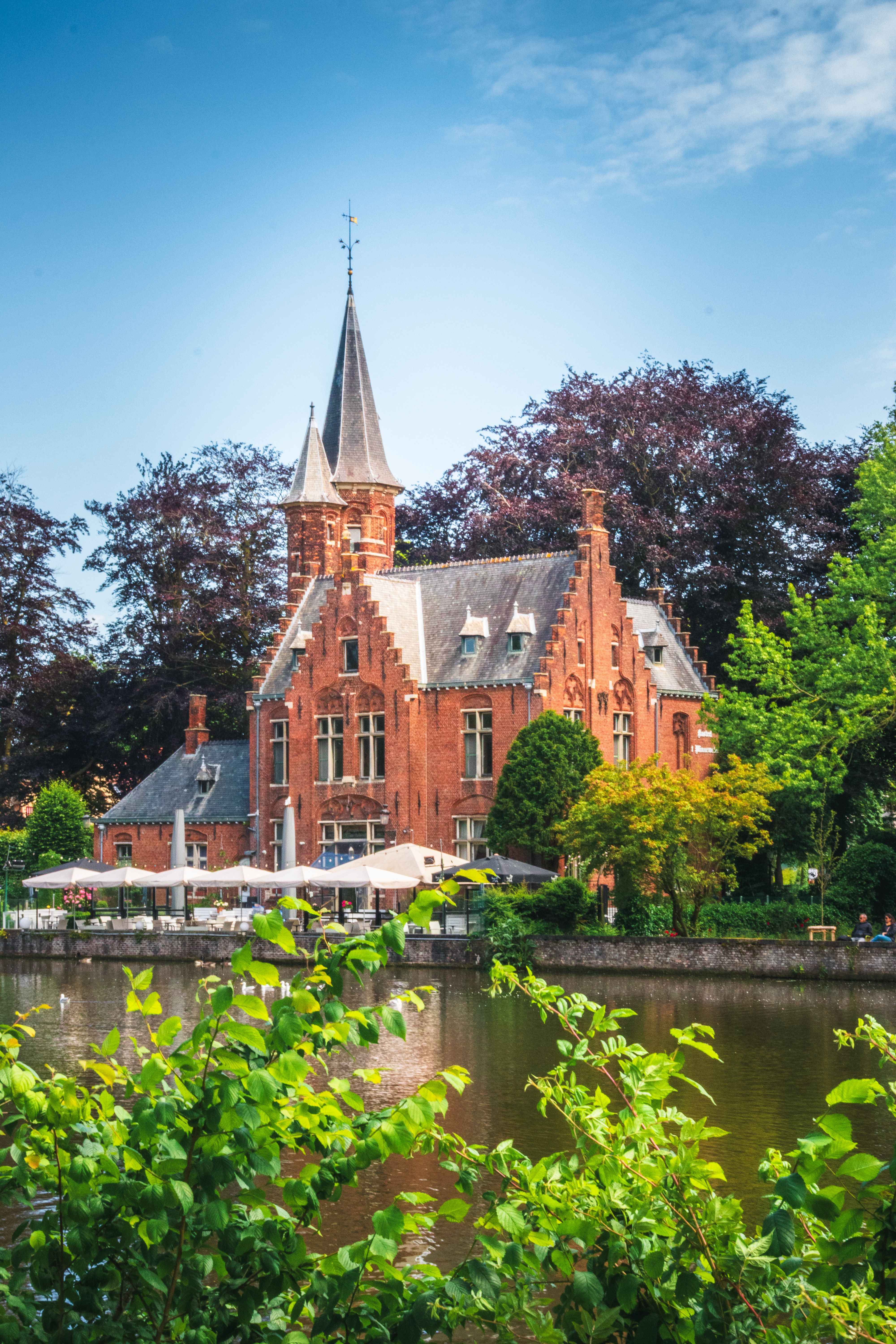 Enchanting Red Brick Castle by Bruges Canal · Free Stock Photo
