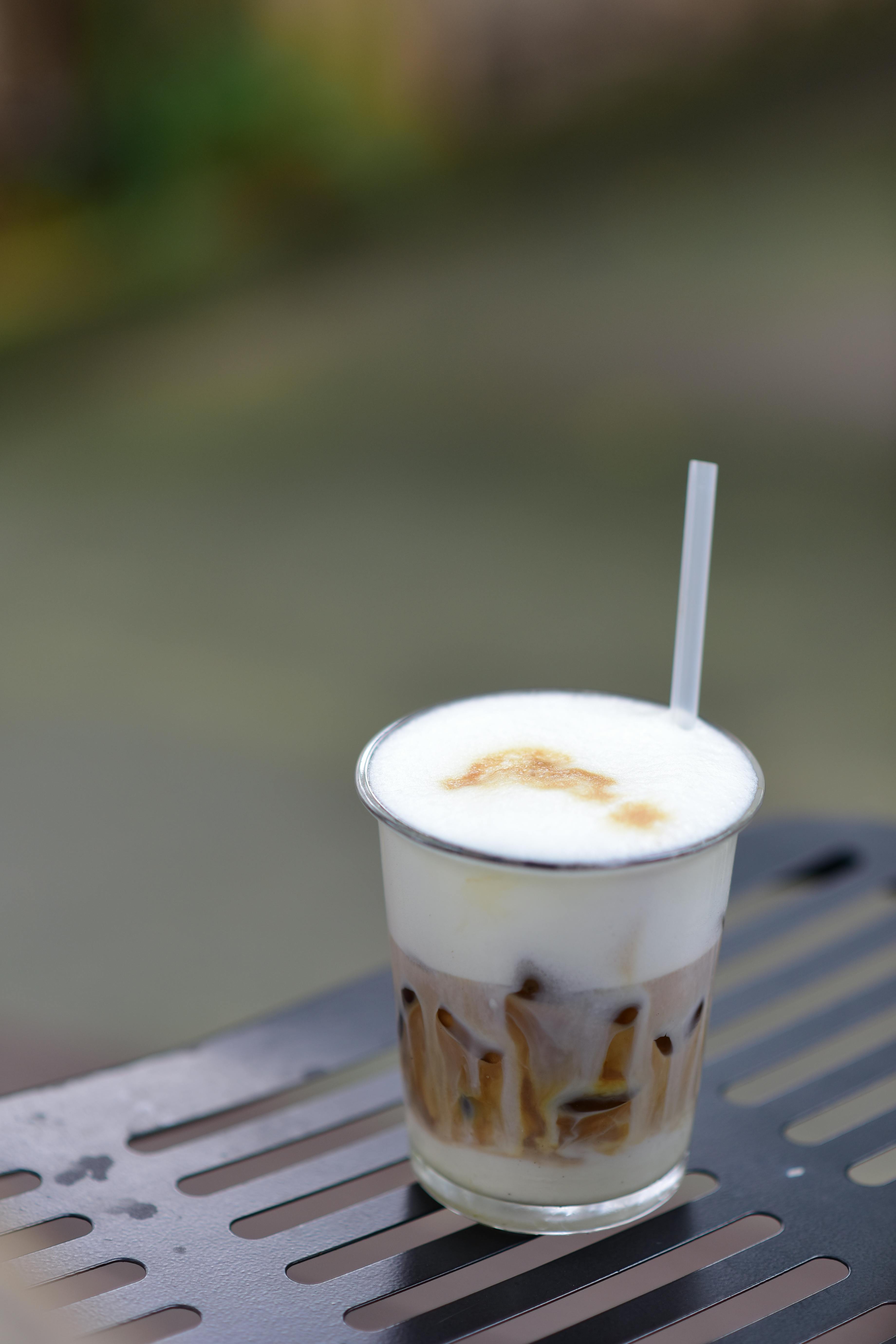 Refreshing Iced Coffee with Creamy Foam Outdoors · Free Stock Photo