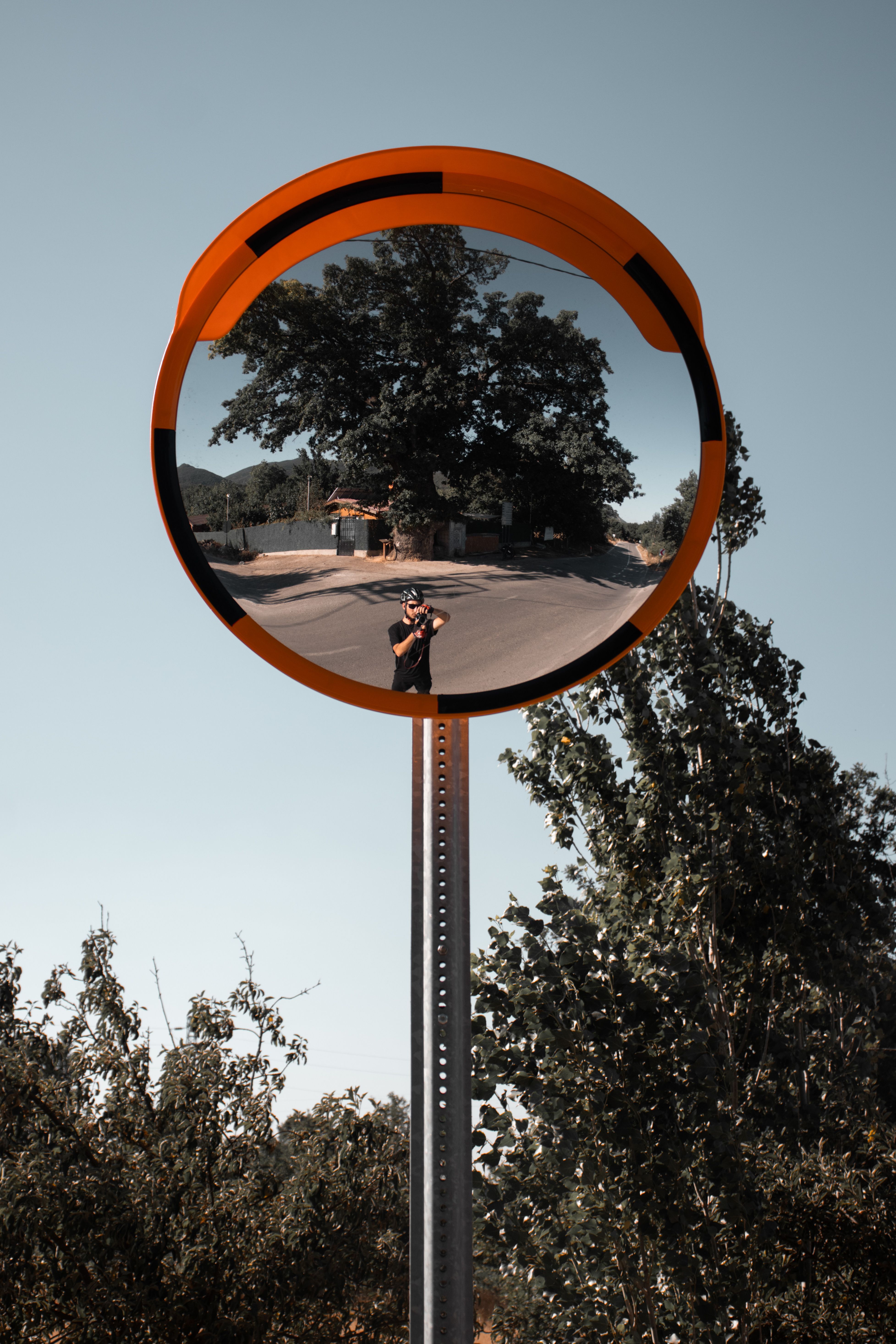 Reflective Roadside Mirror Capturing Photographer · Free Stock Photo