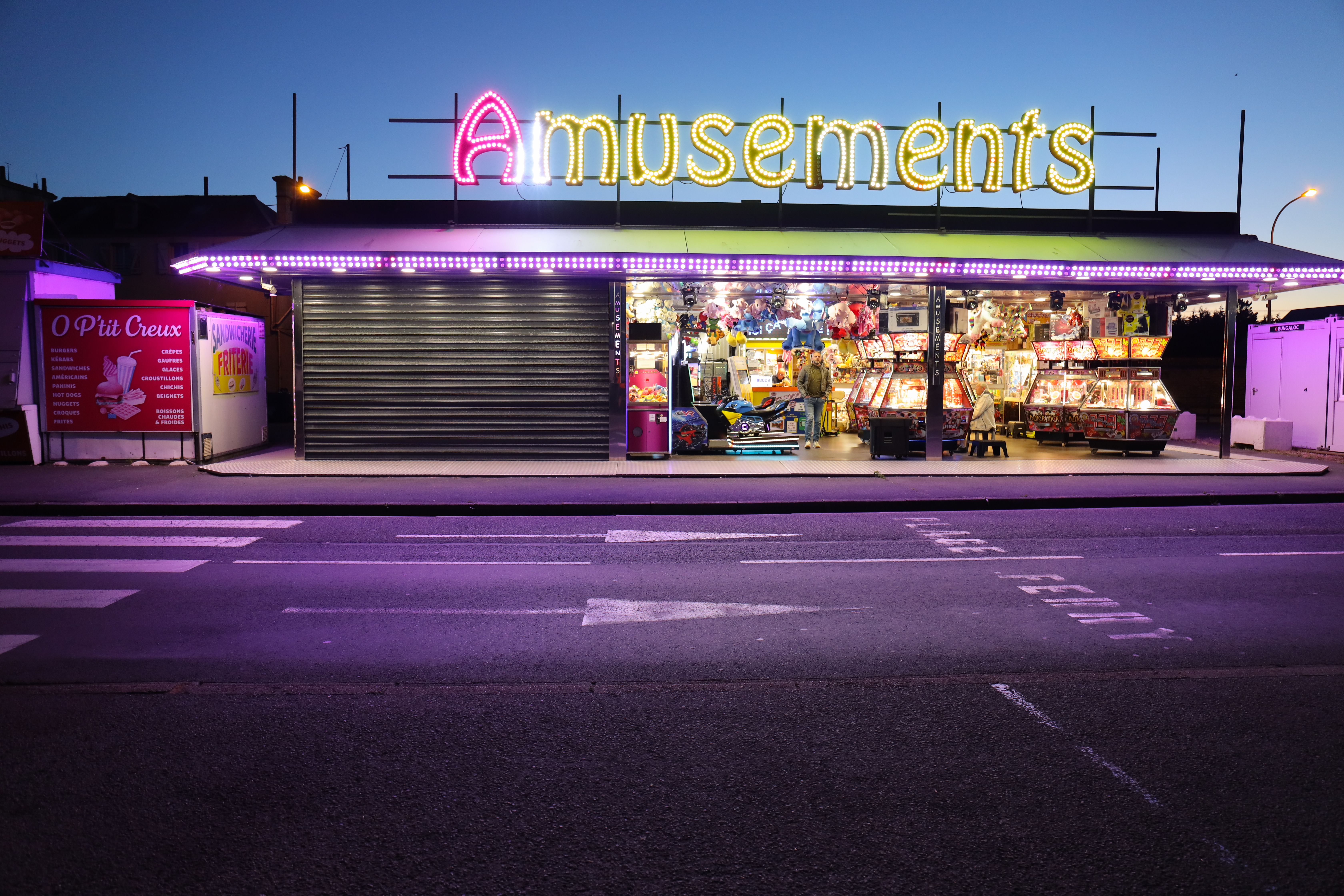 Vibrant Neon Amusement Arcade in Normandy at Night · Free Stock Photo