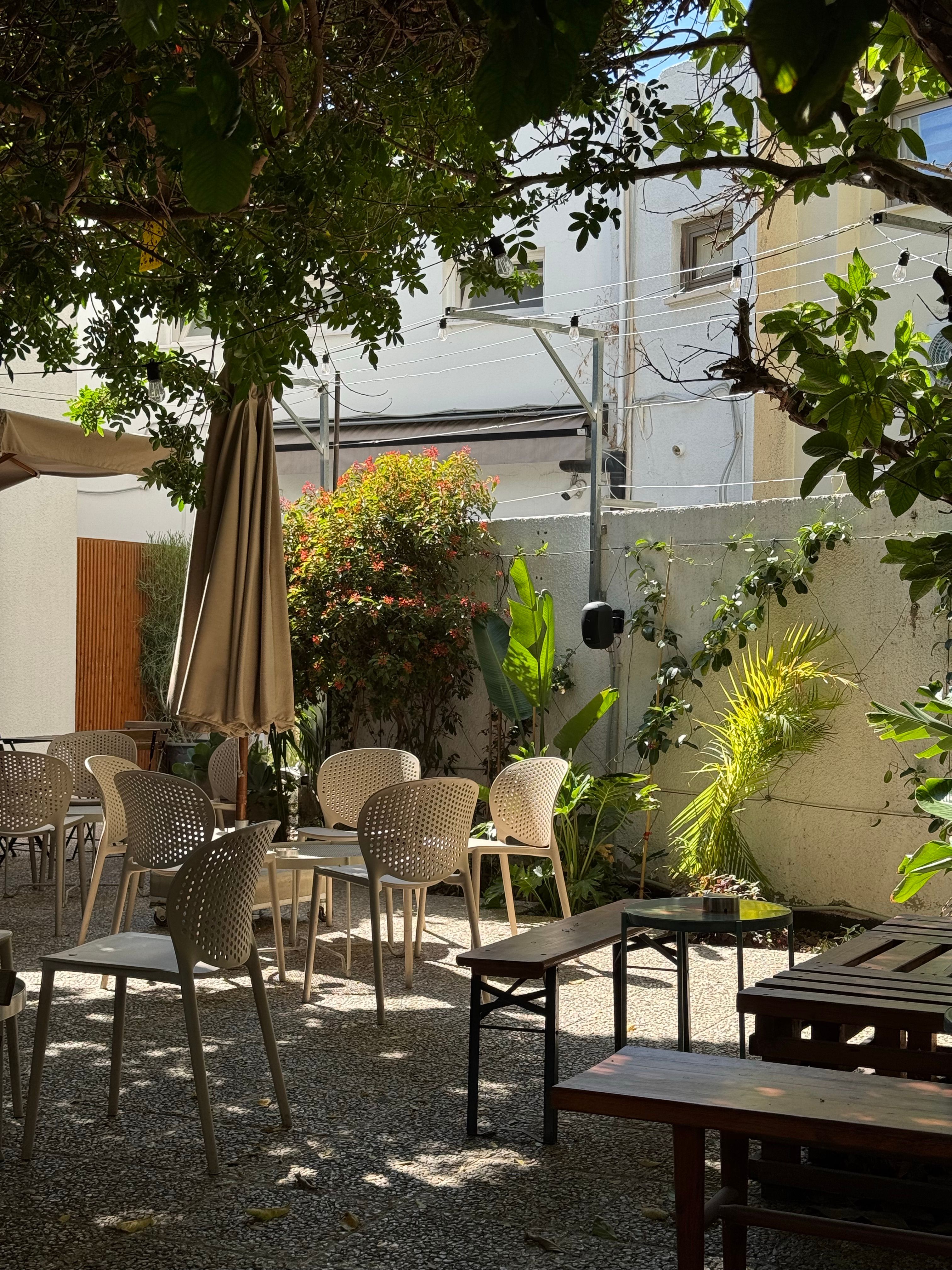 Cozy Outdoor Cafe Seating with Umbrella · Free Stock Photo