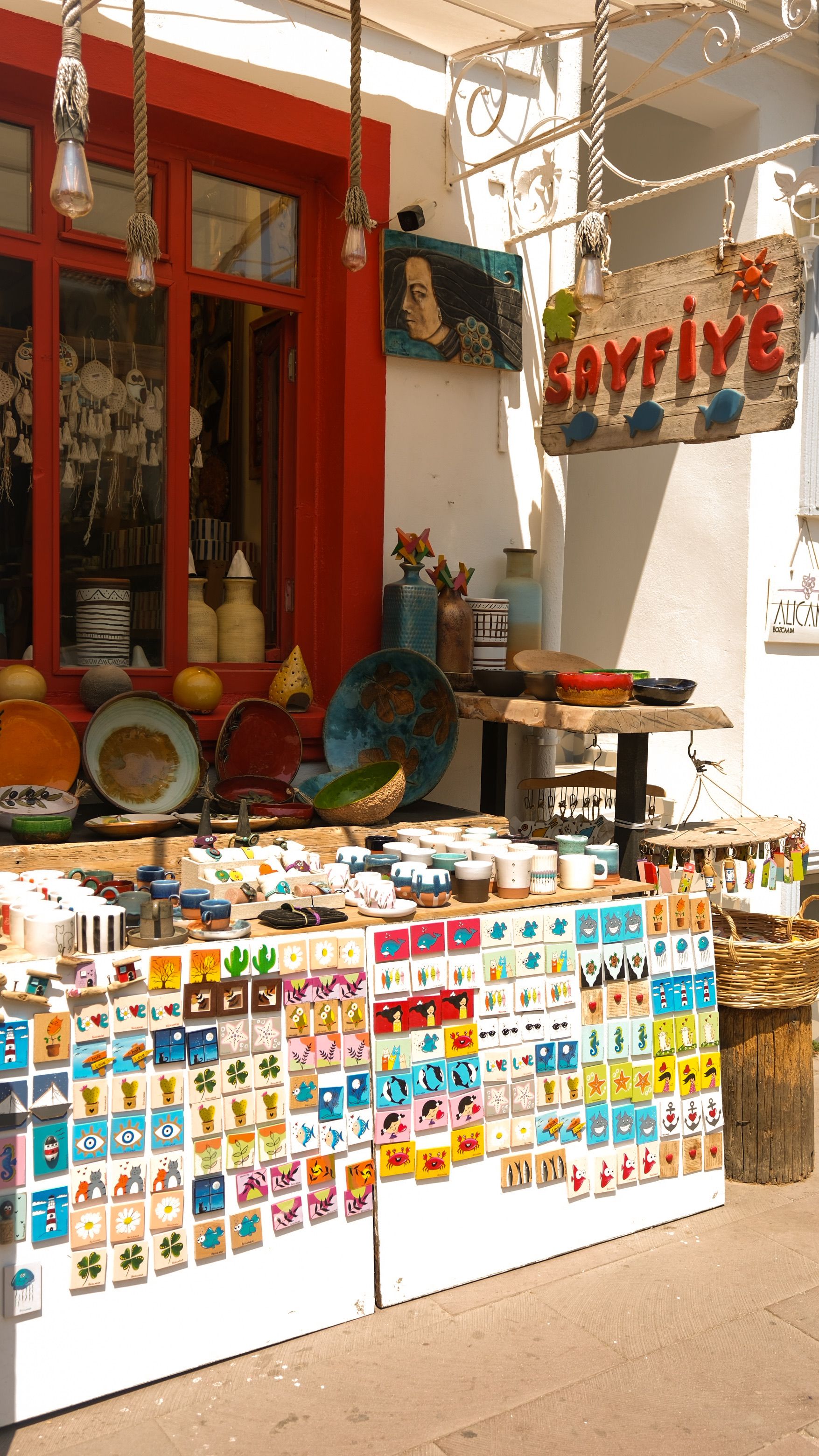 Colorful Local Souvenir Shop Display in Sunlight · Free Stock Photo