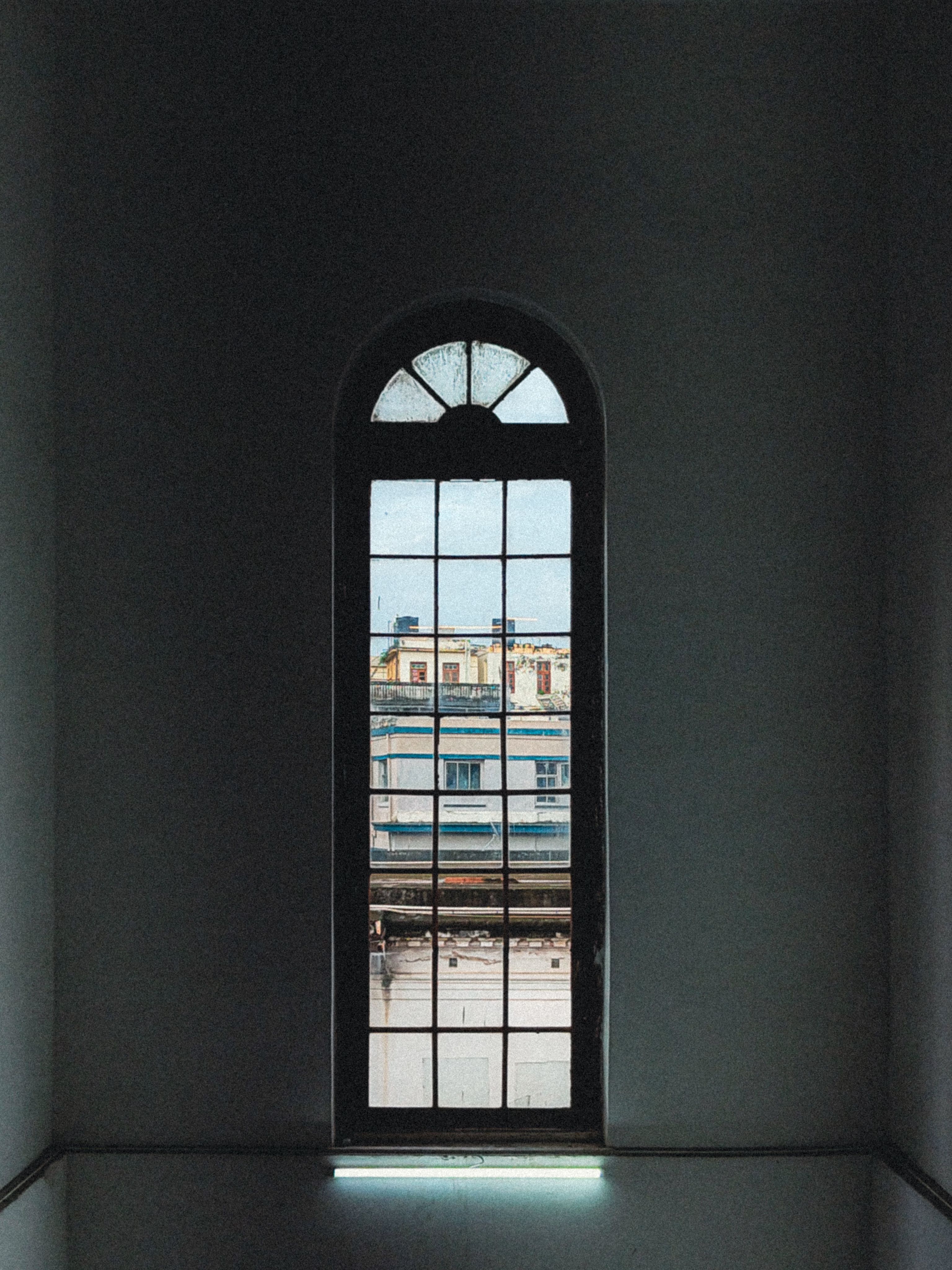 View Through Arched Window onto Cityscape · Free Stock Photo