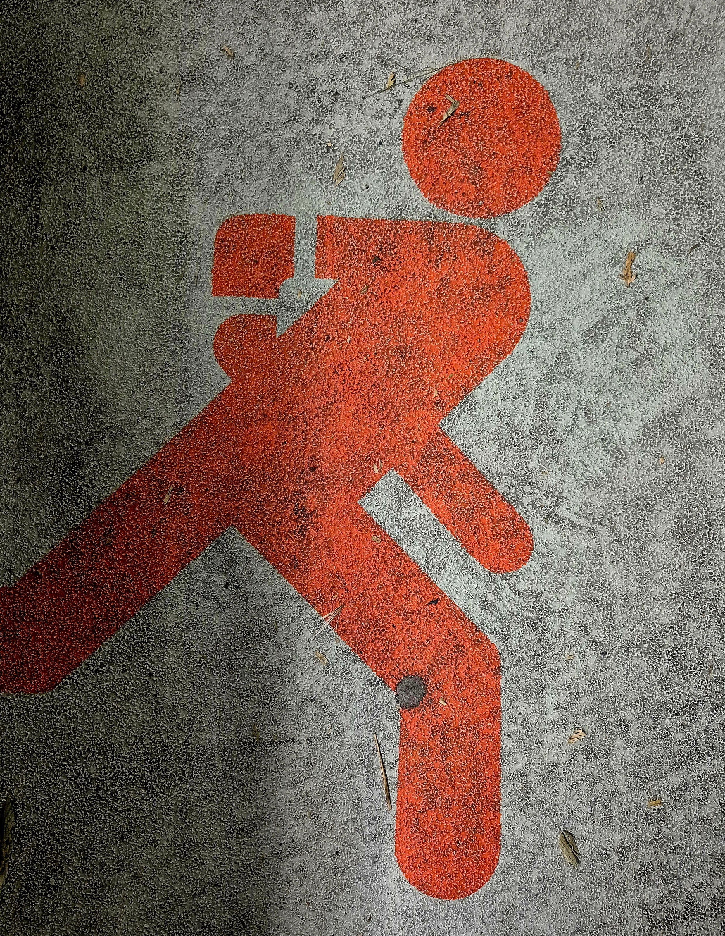 Walking Path Symbol on Concrete Ground · Free Stock Photo