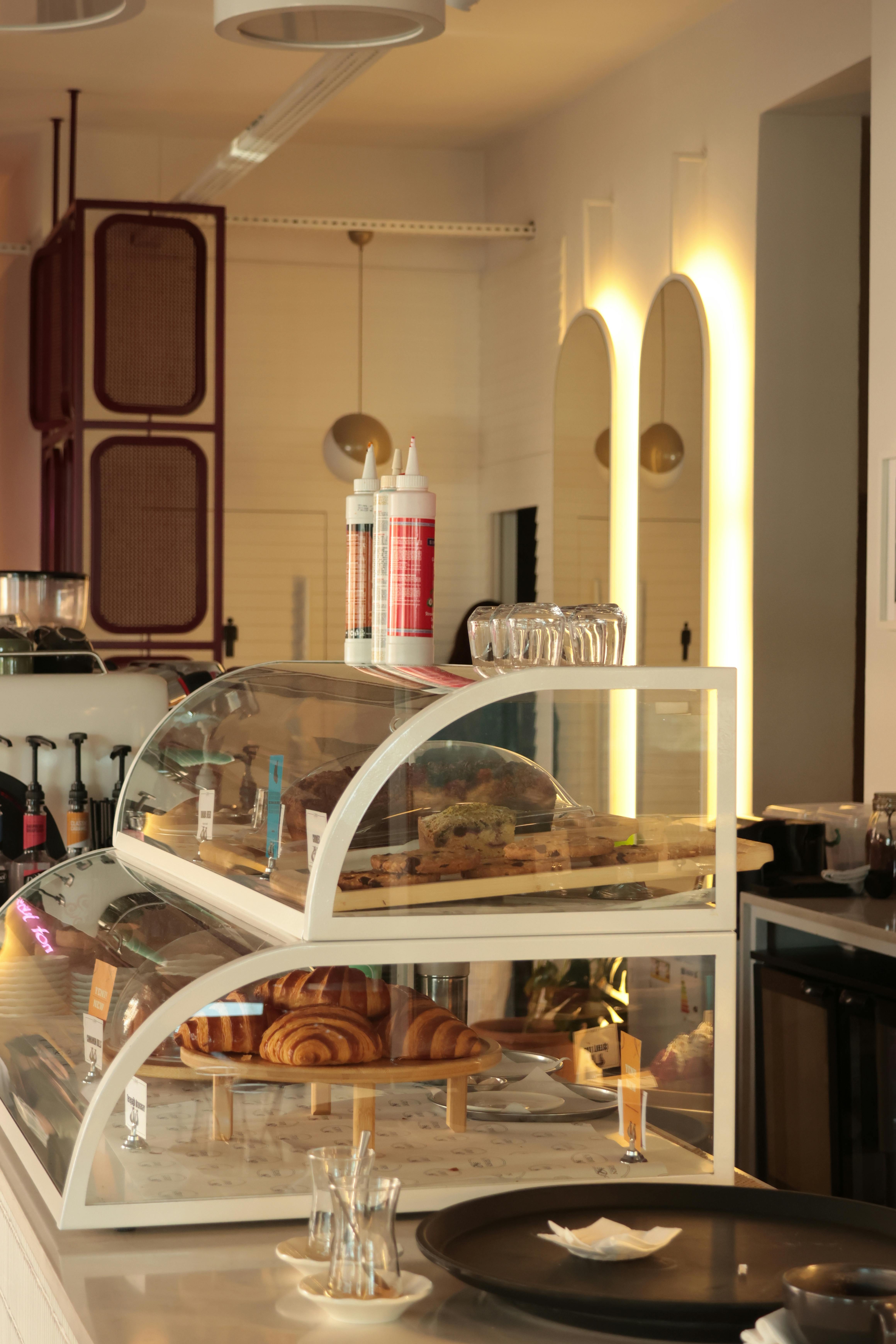 Chic Cafe Pastry Display with Warm Lighting · Free Stock Photo