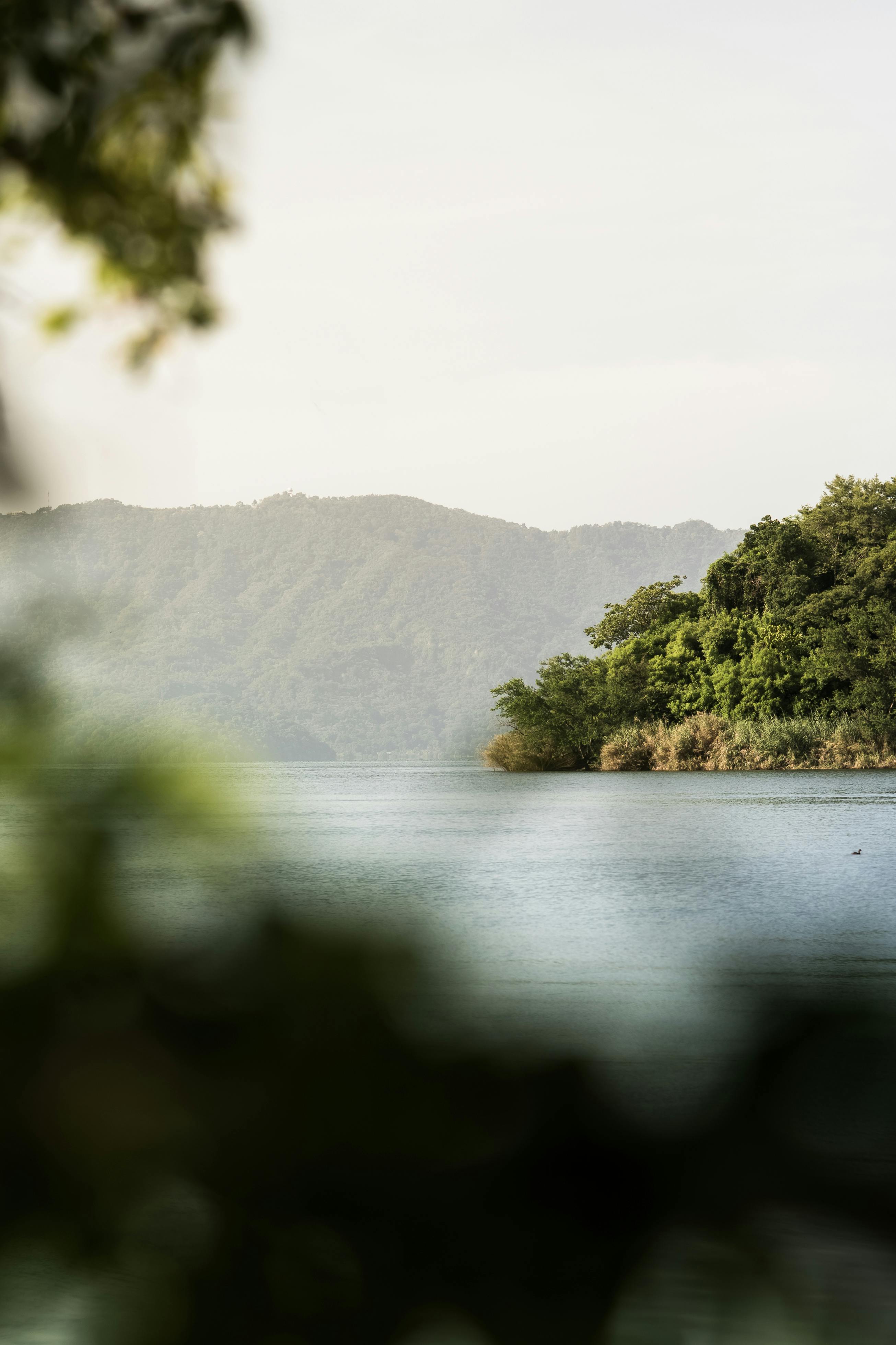 Serene El Salvador Lake with Lush Green Hills · Free Stock Photo
