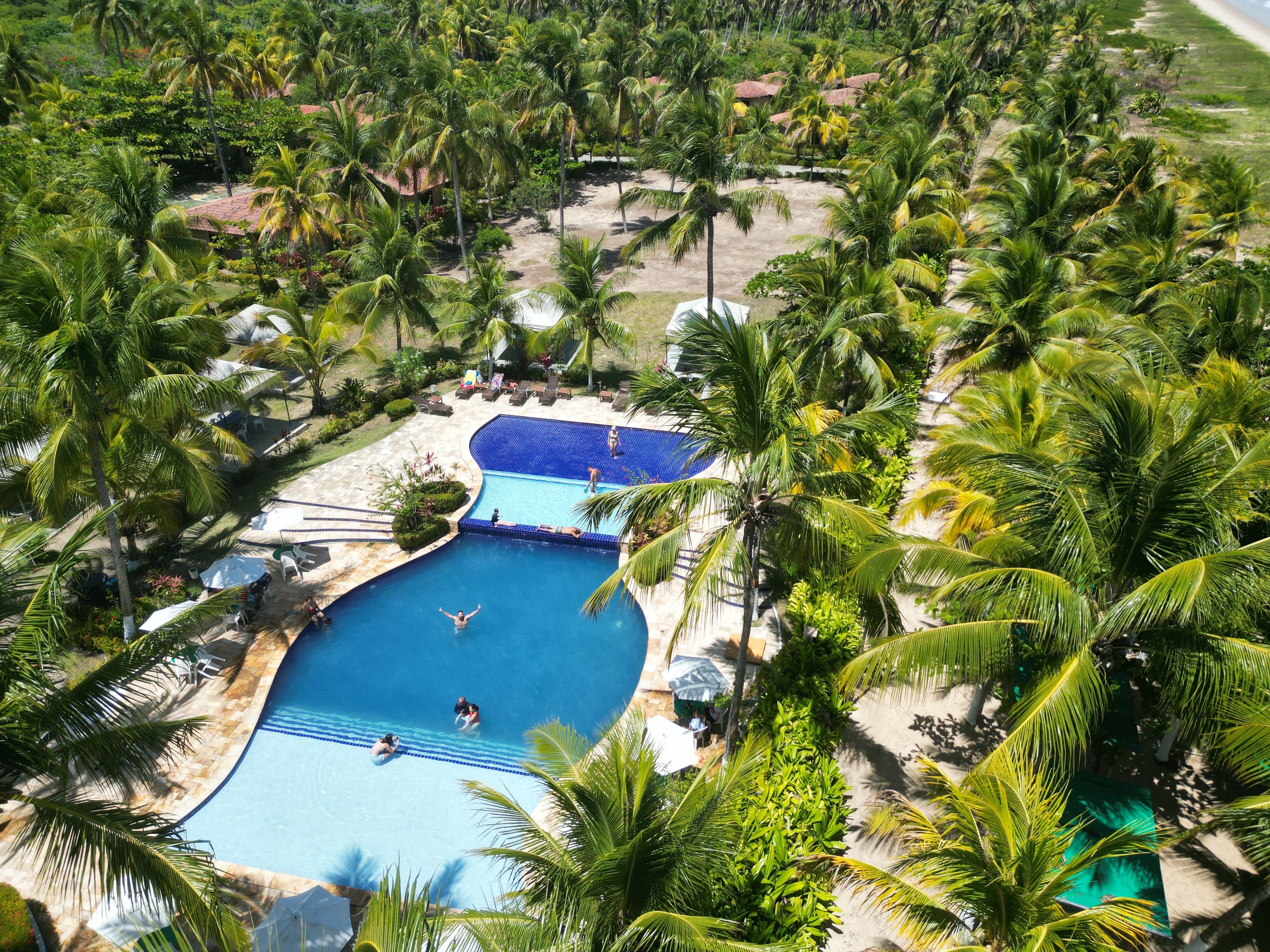 Aerial View of Tropical Resort with Pools and Palm Trees · Free Stock Photo