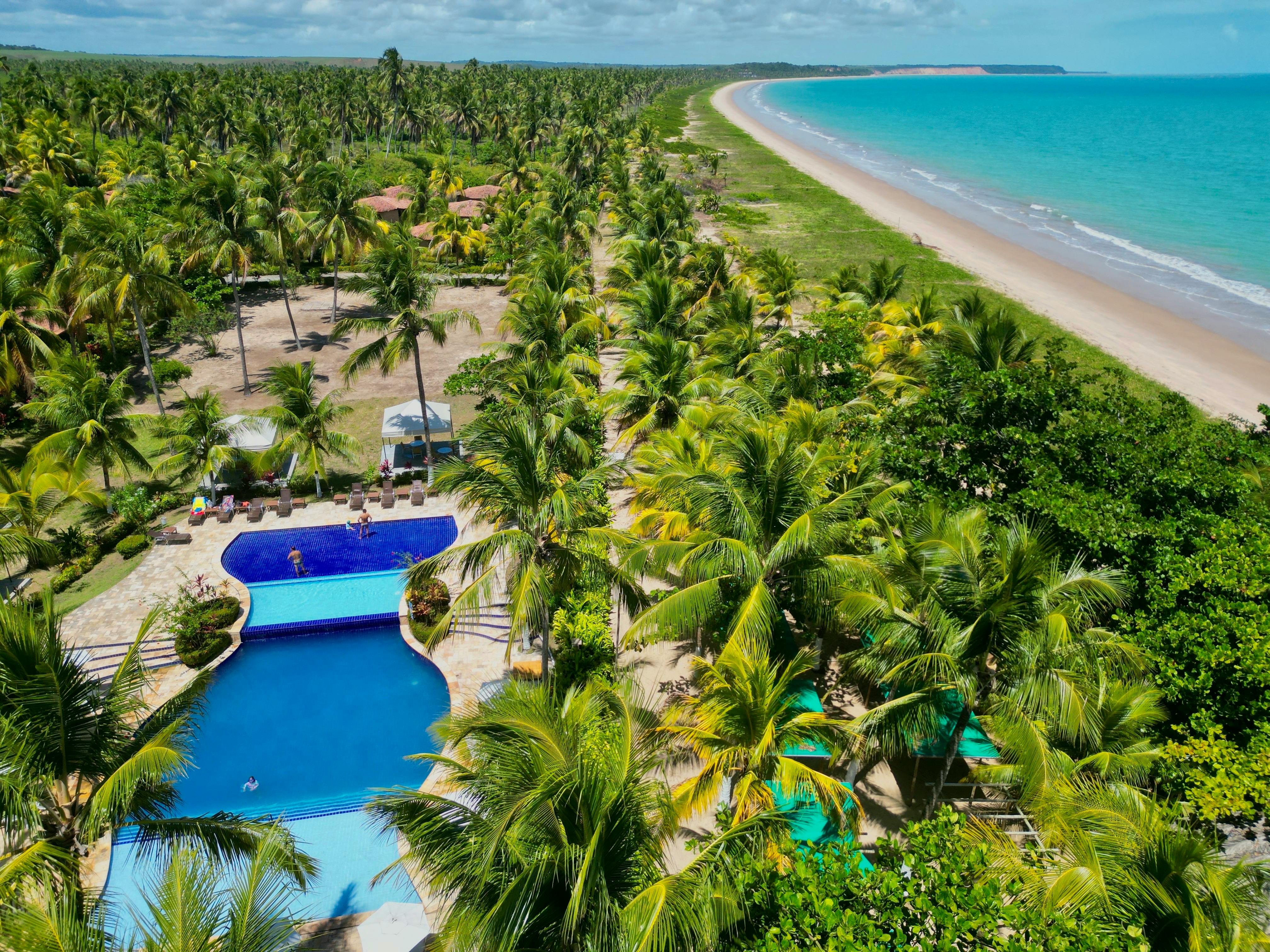 Aerial View of Tropical Poolside Beach Resort · Free Stock Photo