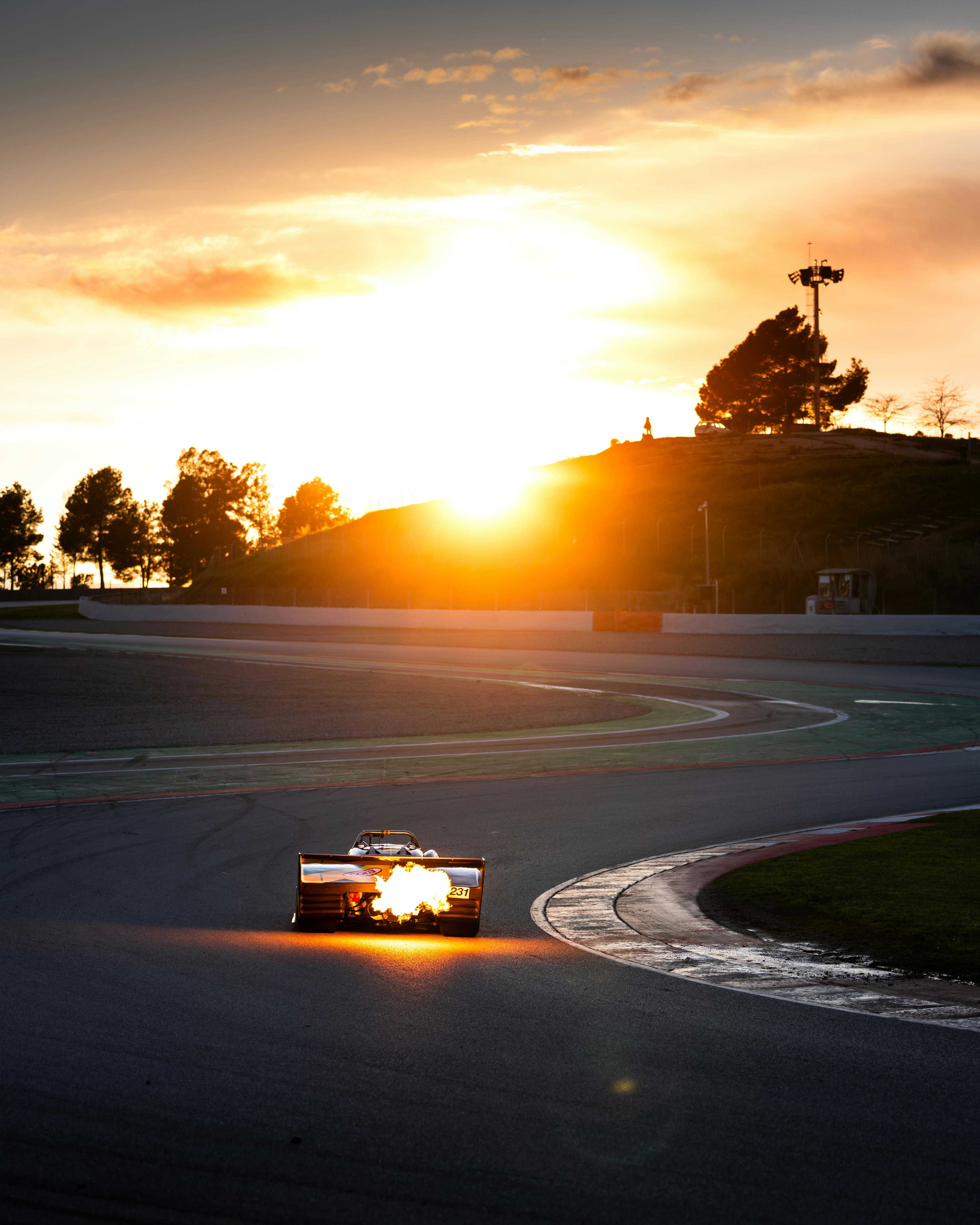 Dynamic racing car at sunset on track · Free Stock Photo