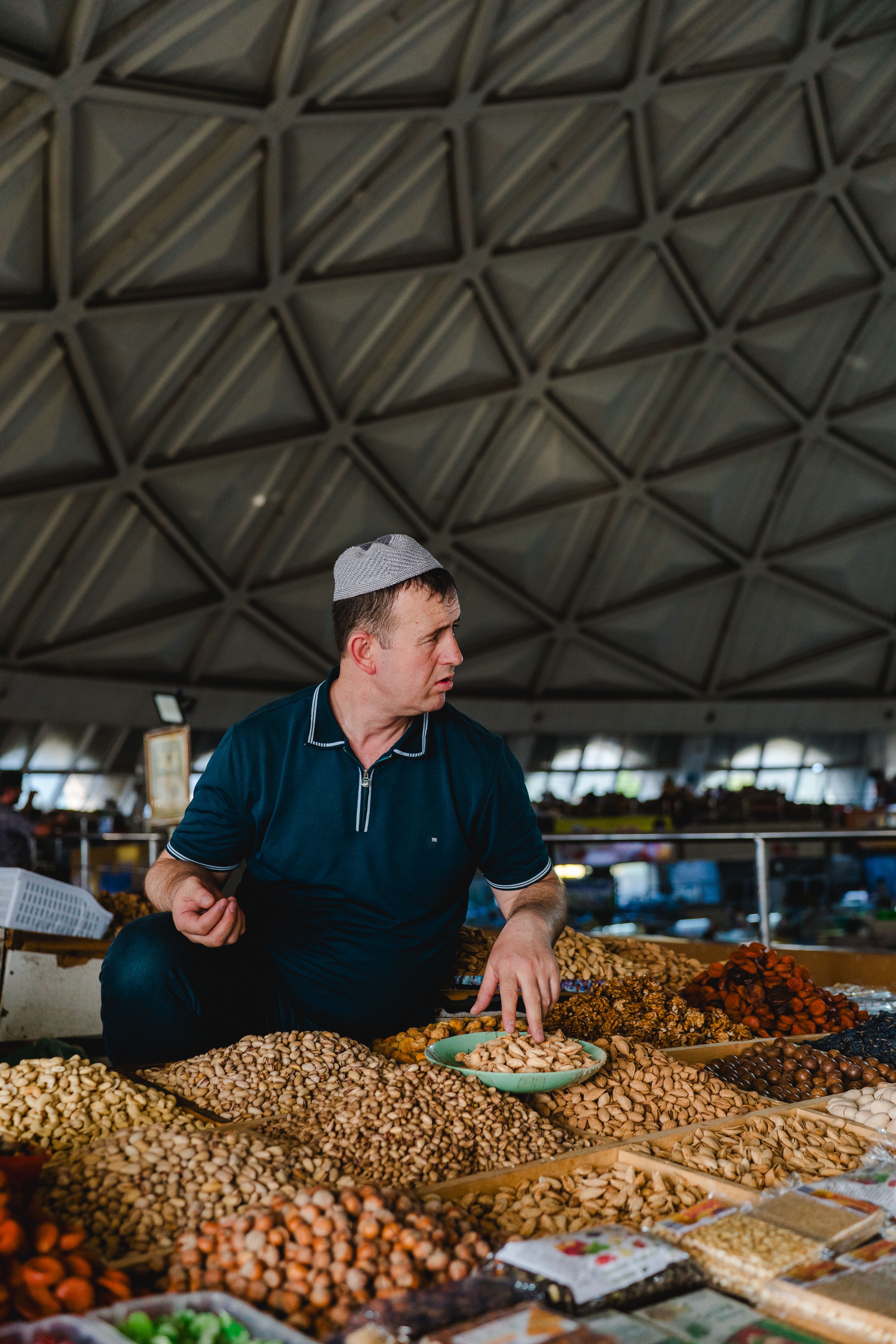 Vendor Selling Nuts in Indoor Market · Free Stock Photo