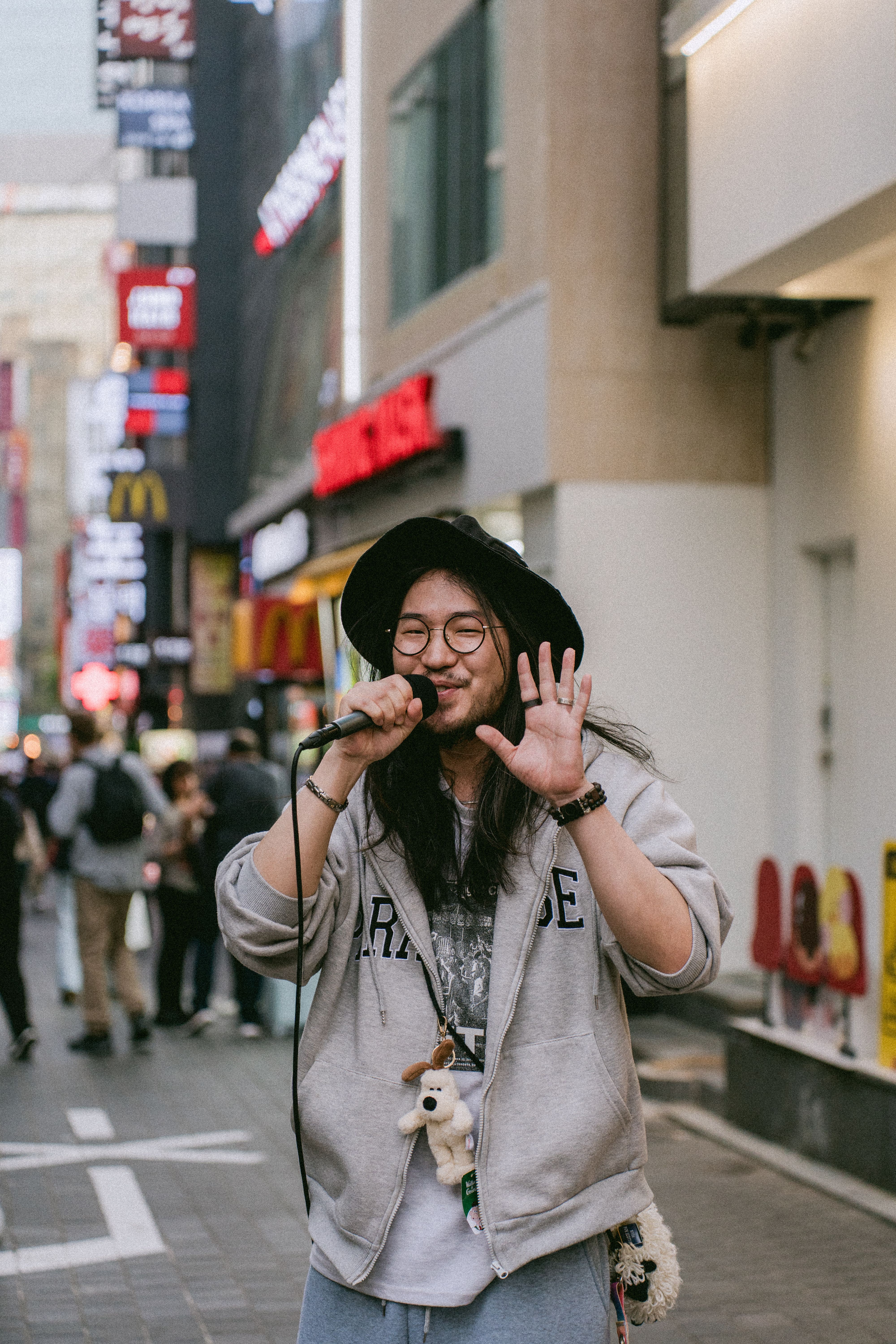 Street Performer Singing in Bustling City Area · Free Stock Photo